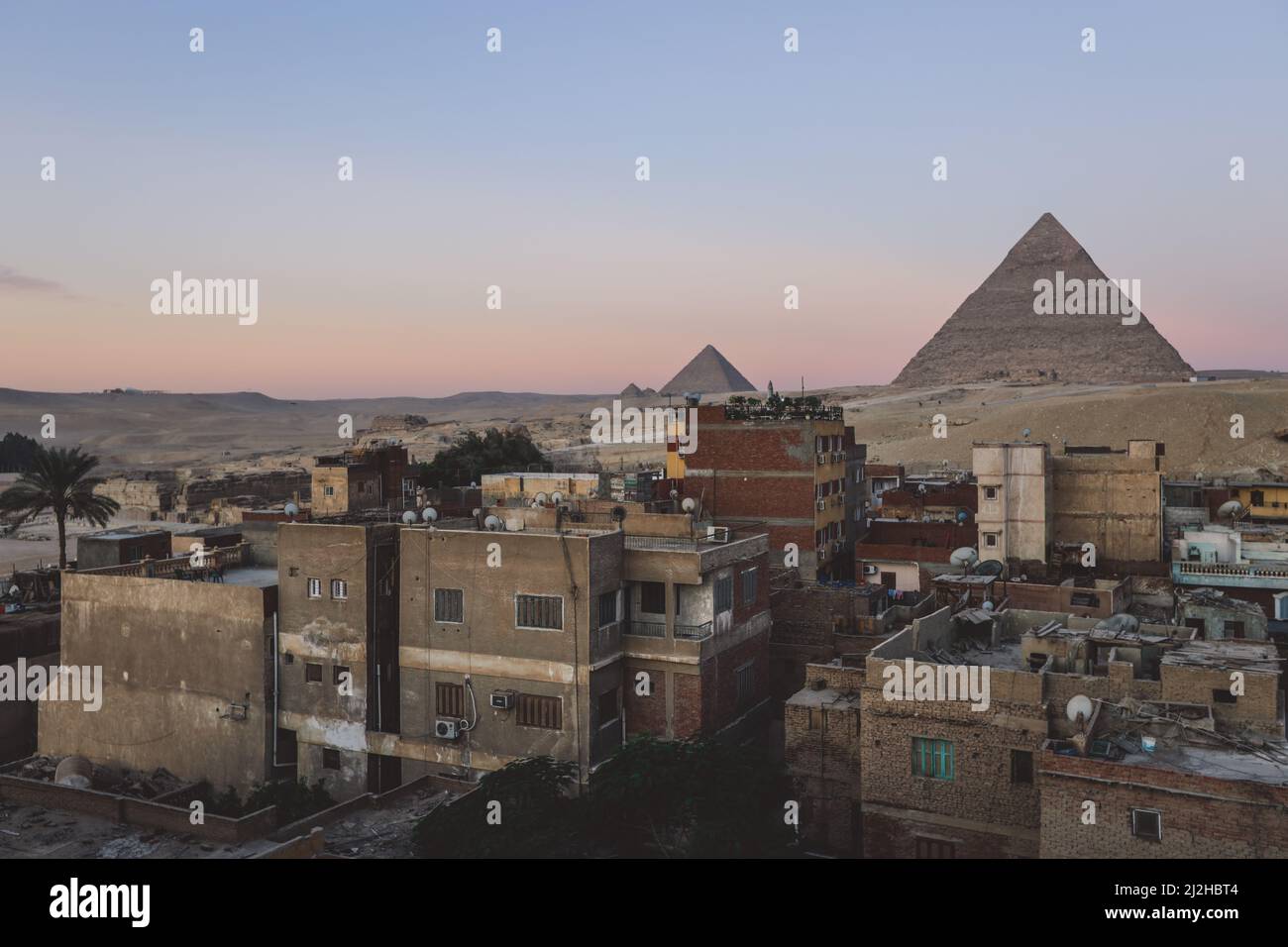 View of the Pyramids of Giza from the city in the evening Stock Photo ...