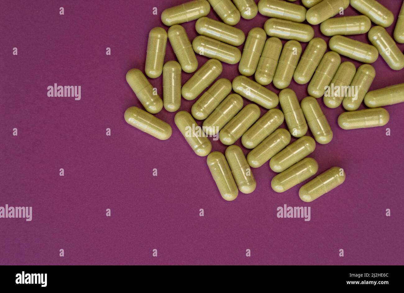 A top view of the barley grass capsules rich in vitamins A and C on the ...