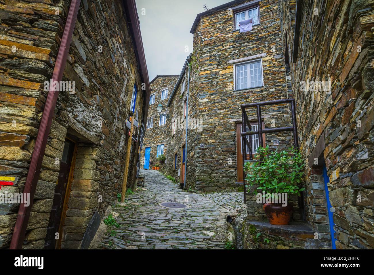 A narrow street between stone houses in Piodao, Aldeias de Xisto ...