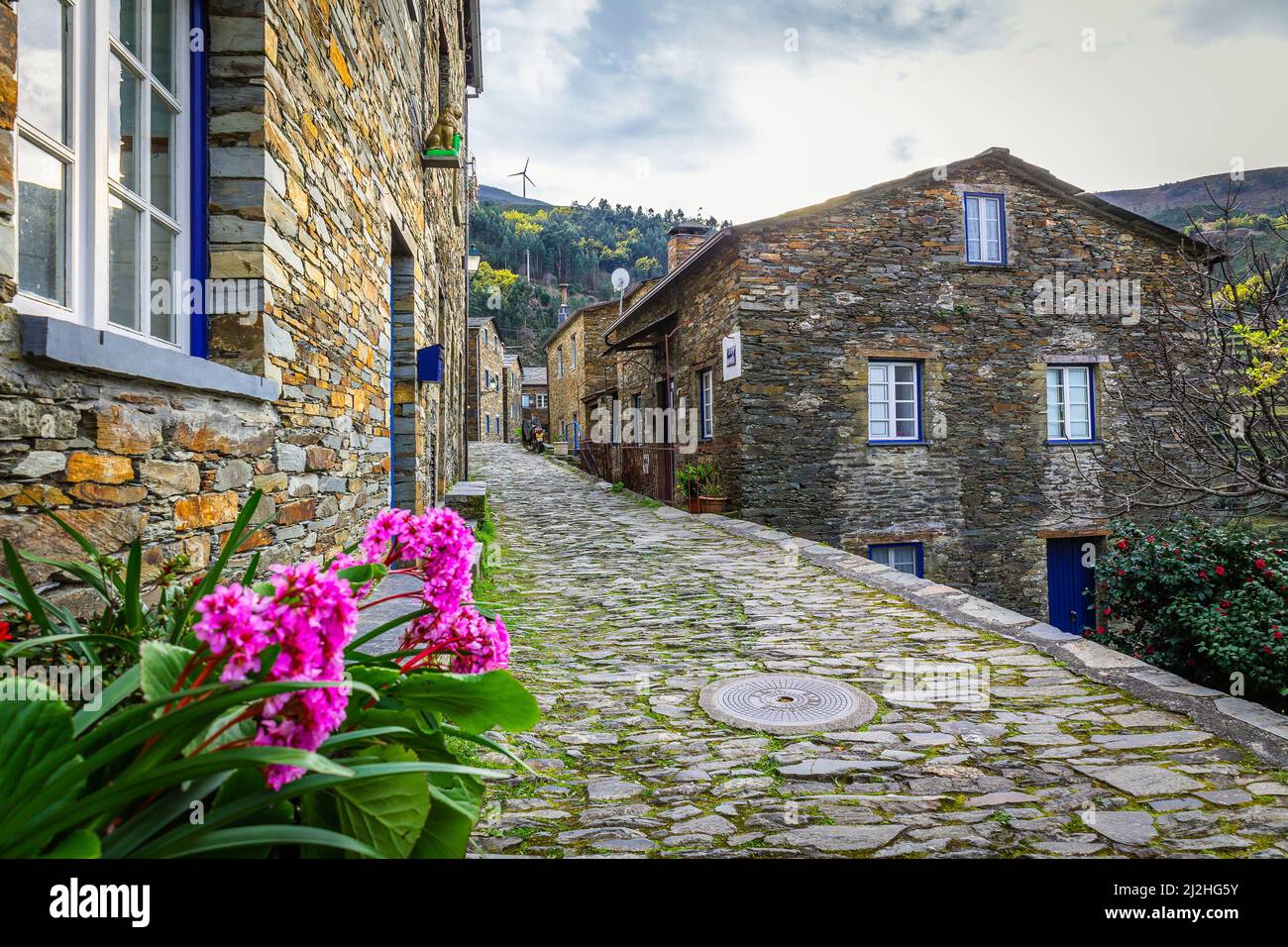 A narrow street between stone houses in Piodao, Aldeias de Xisto ...