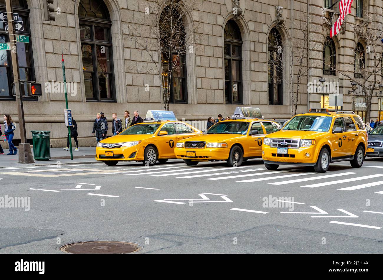 Yellow Taxi cabs, three different types of cars, waiting for the ...