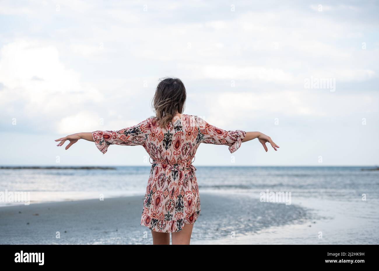 Woman walking in freedom open hands in the beach. Enjoying ocean Summer ...