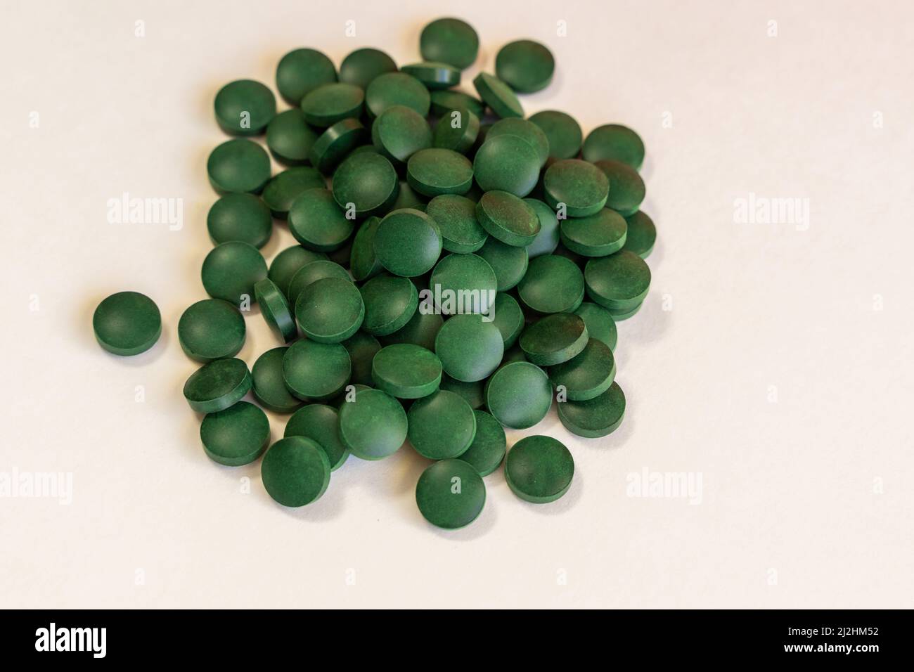 A closeup shot of green Spirulina capsules with lots of nutrition iron ...