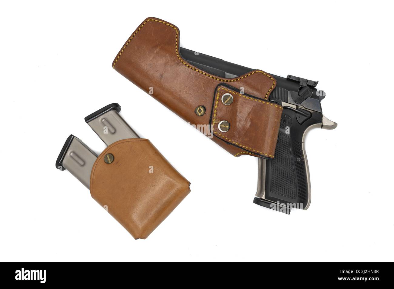 a closeup shot of pistol with leather sheath for quick removal on white ...