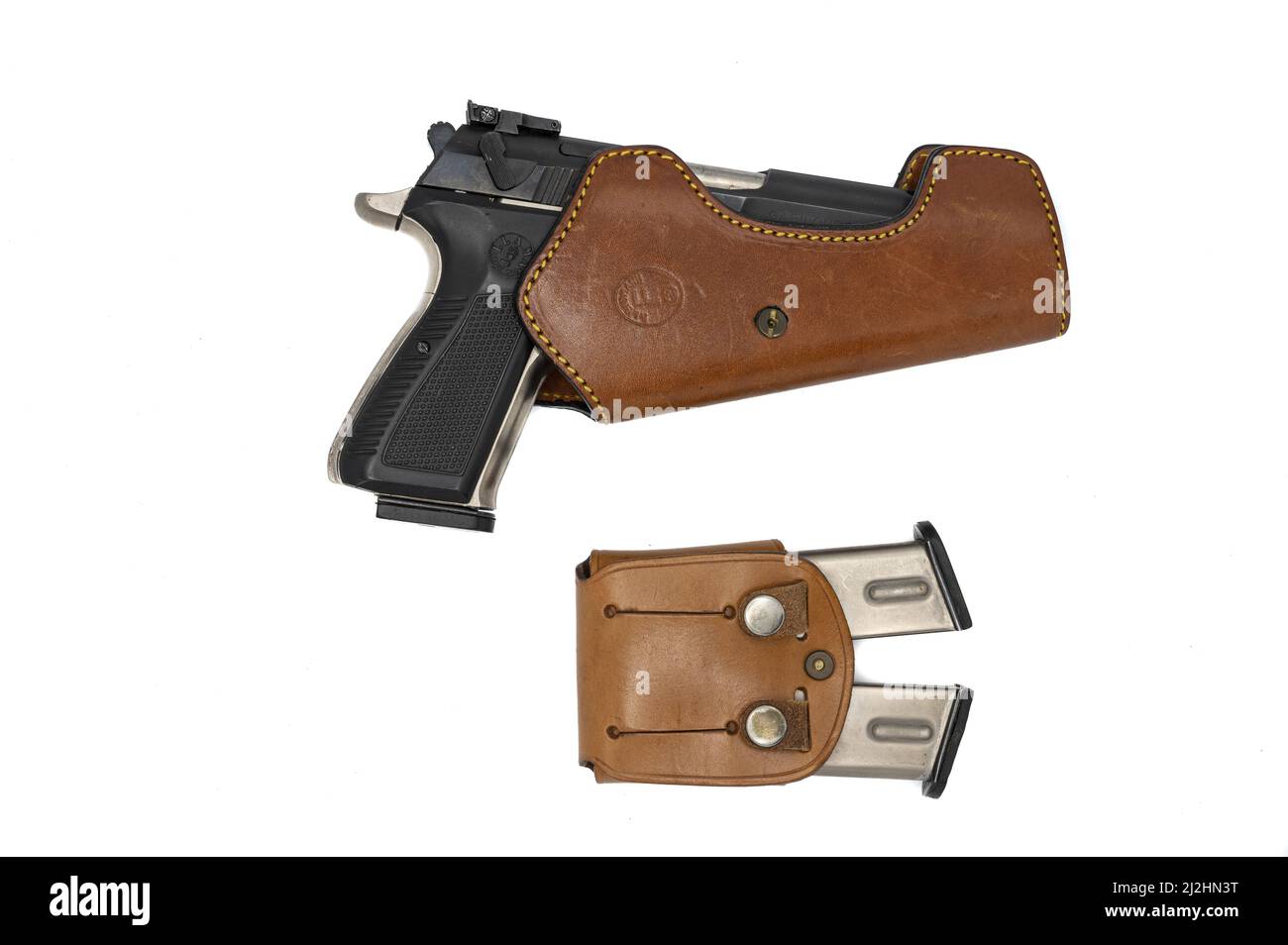 a closeup shot of pistol with leather sheath for quick removal on white ...