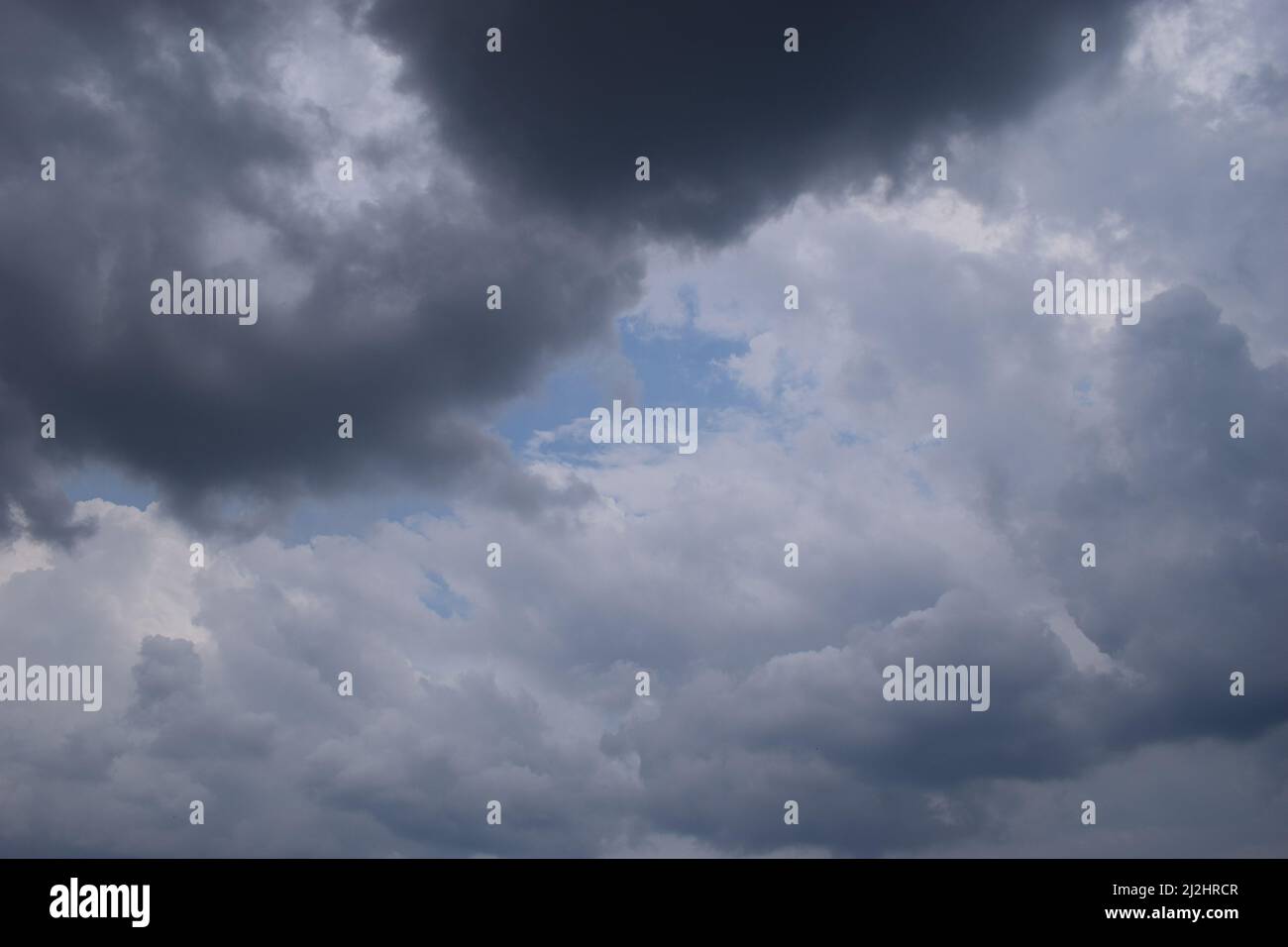 white and some dark clouds in the sky. Natural Dramatic Clouds. Black cloudy and dark sky before ...