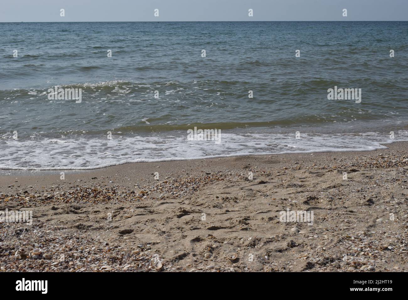 Beautiful landscape - turquoise colored sea water, sand, sky. The waves ...