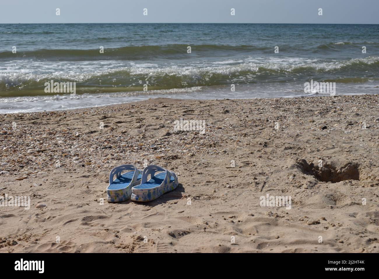 Beautiful beach. Blue Beach sandals on the sandy coast. Summer holiday ...