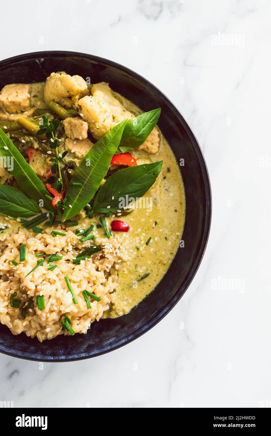 vegan green curry with tofu bell pepper and cauliflower served with ...