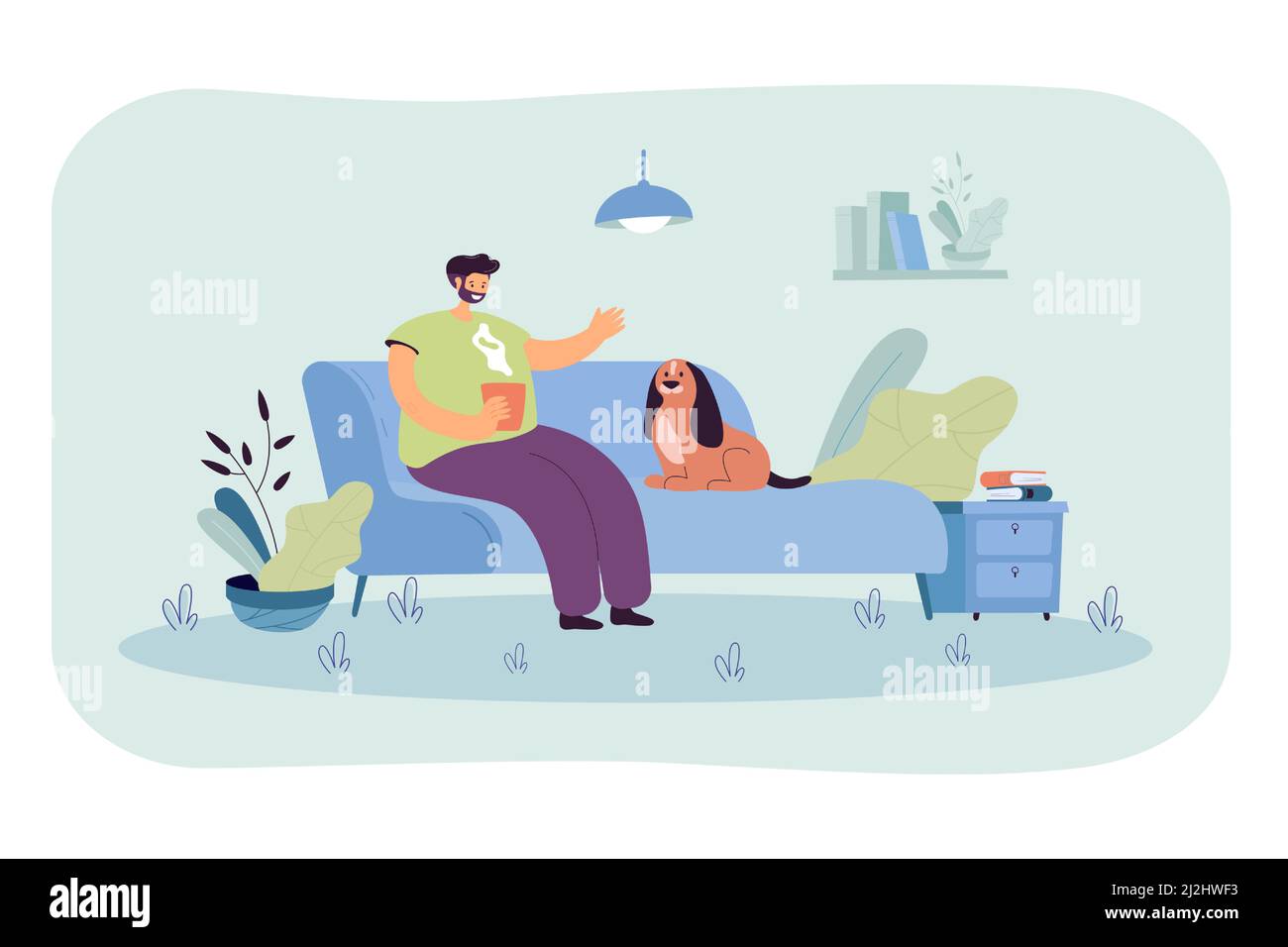 Man holding cup of coffee sitting on sofa with his dog. Spending time ...
