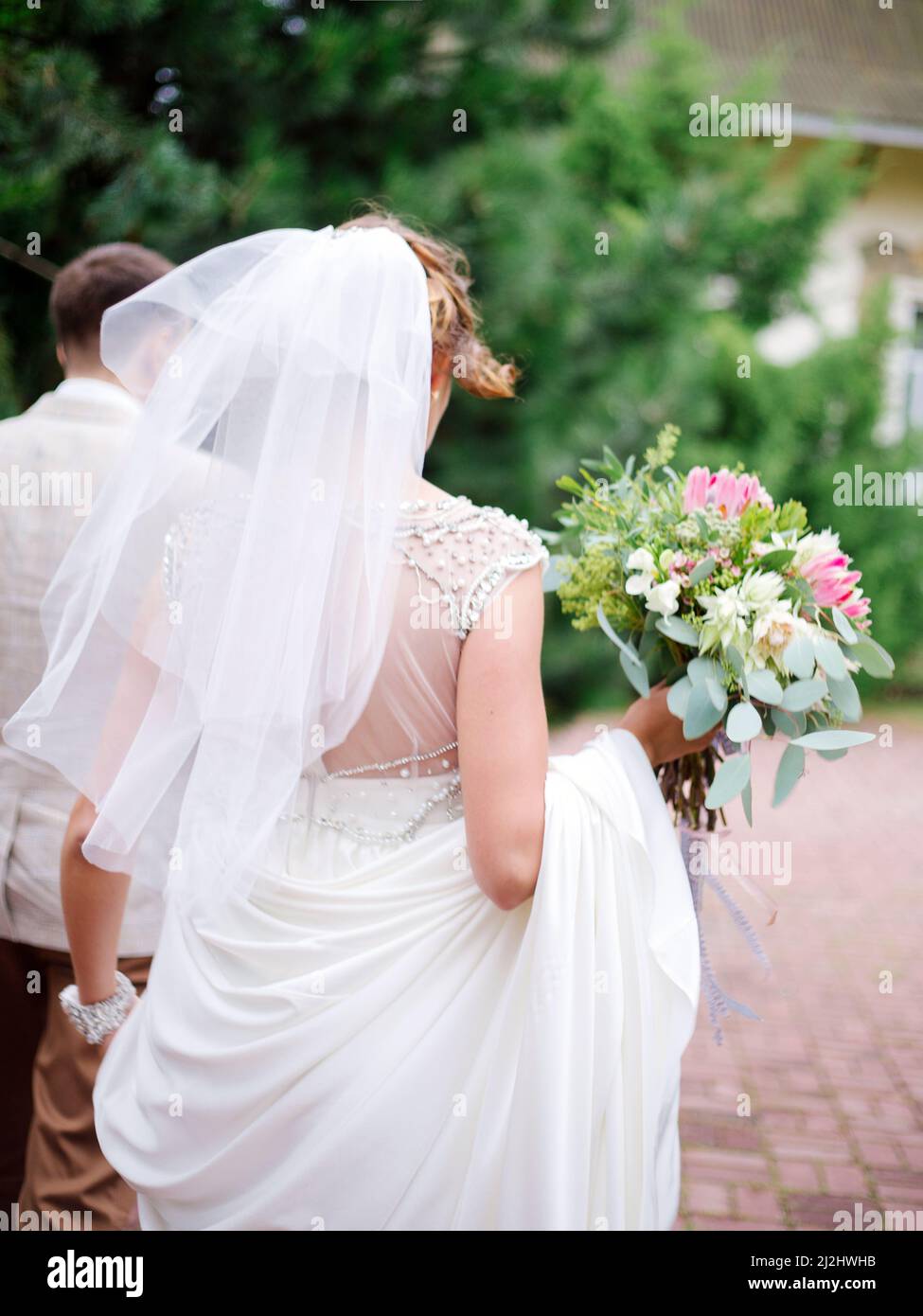 Bride and groom walking away hi-res stock photography and images - Alamy