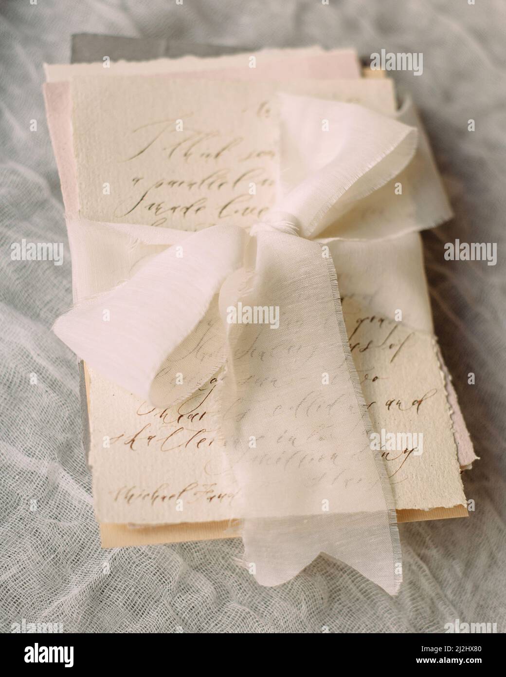 invitation card with handwritten text and white ribbon Stock Photo - Alamy