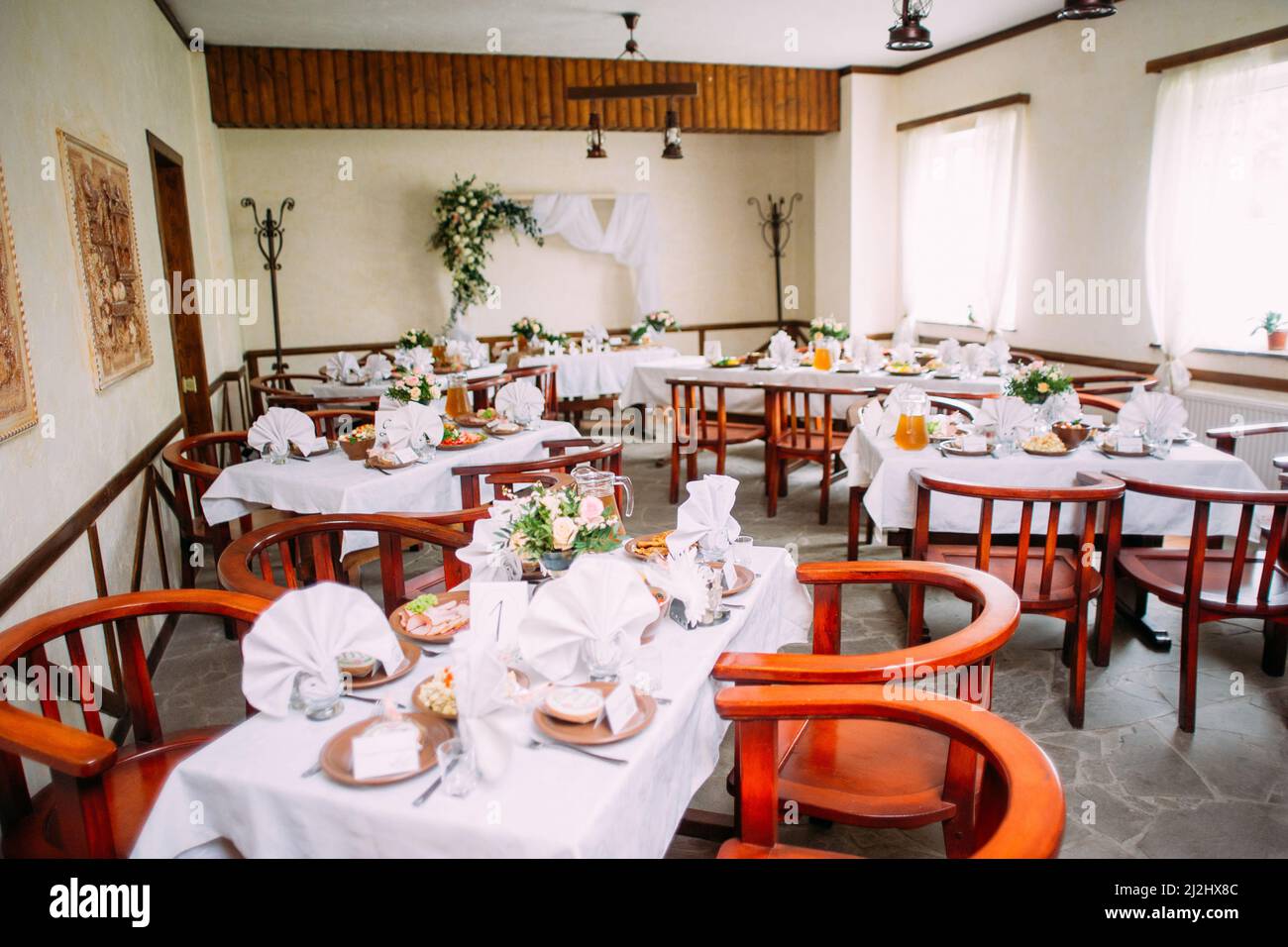 Rustic wedding style. Restaurant interior decorated for wedding dinner ...