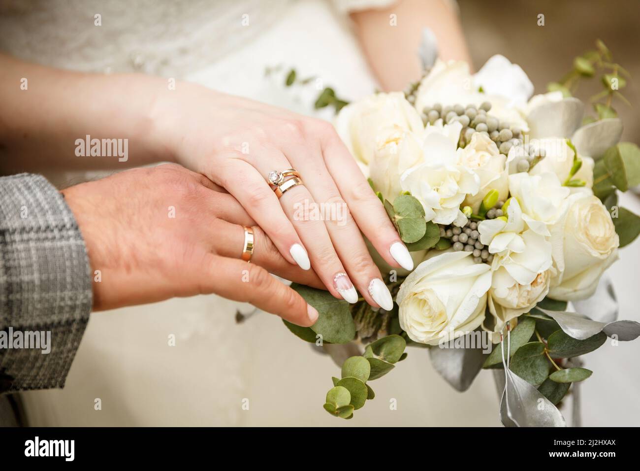 Married couple hands wearing golden rings Stock Photo - Alamy