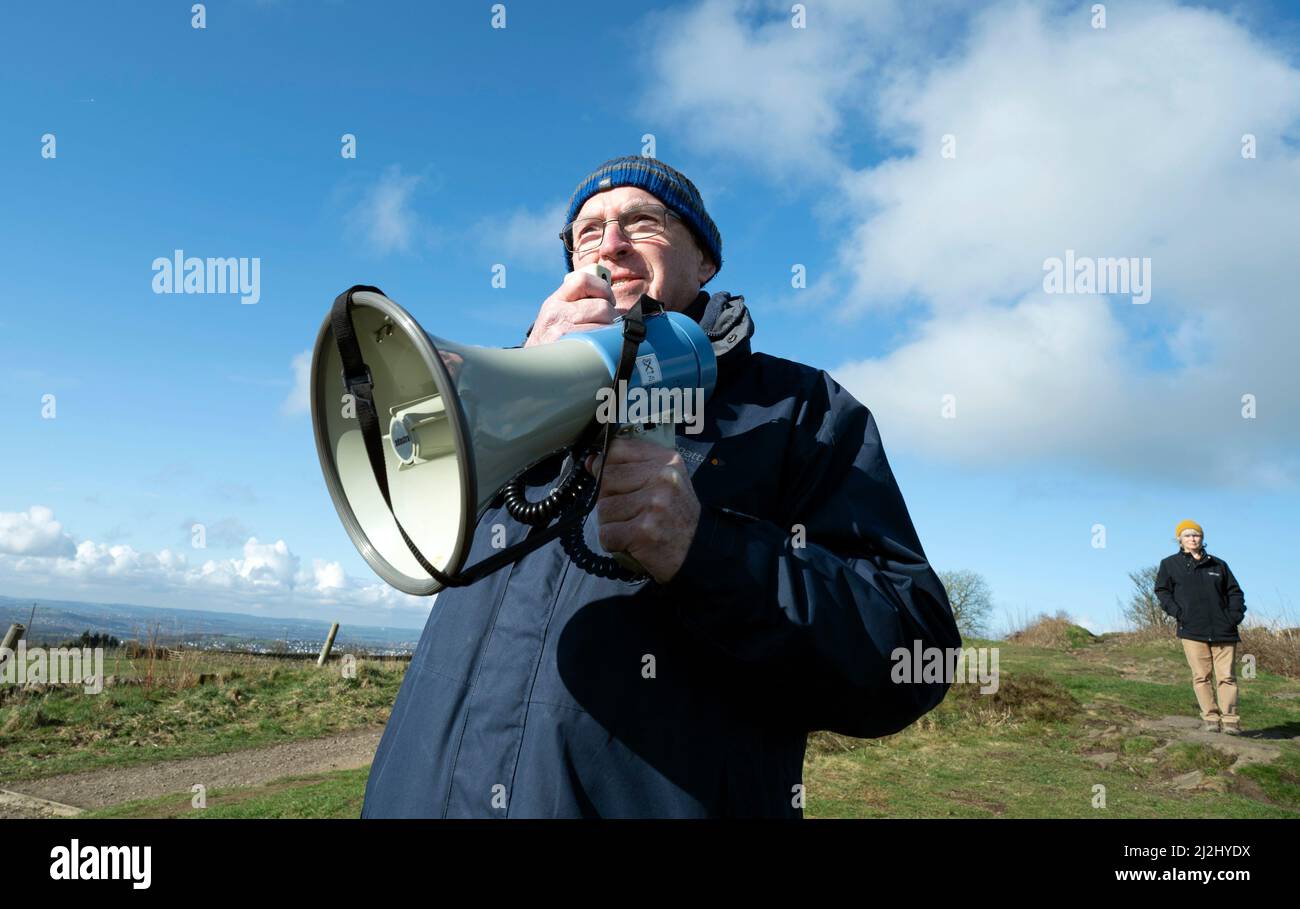 A man gives instructions as a 30-foot high cross is constructed on the ...
