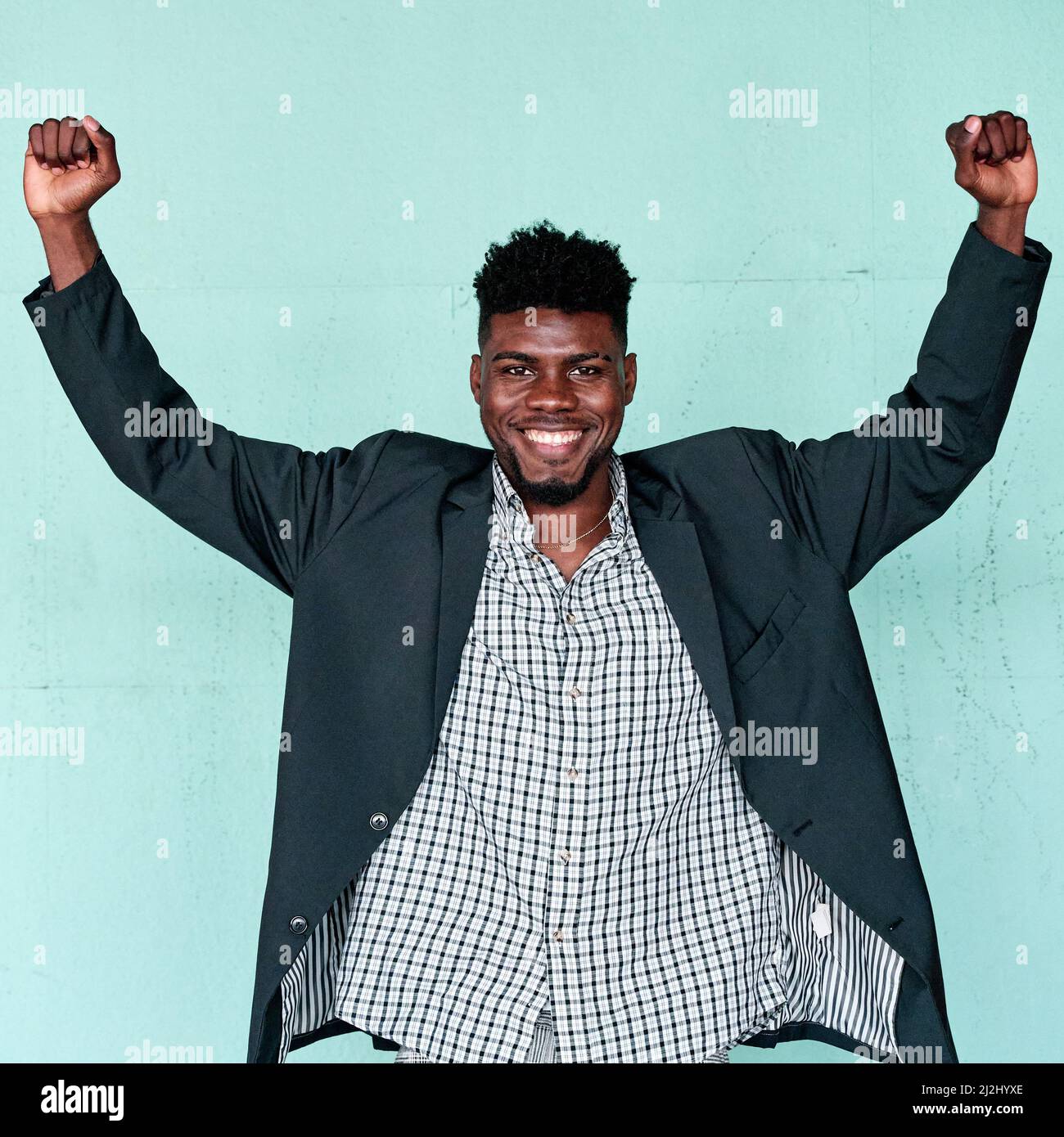 Young african american man with beard wearing casual blazer celebrating ...