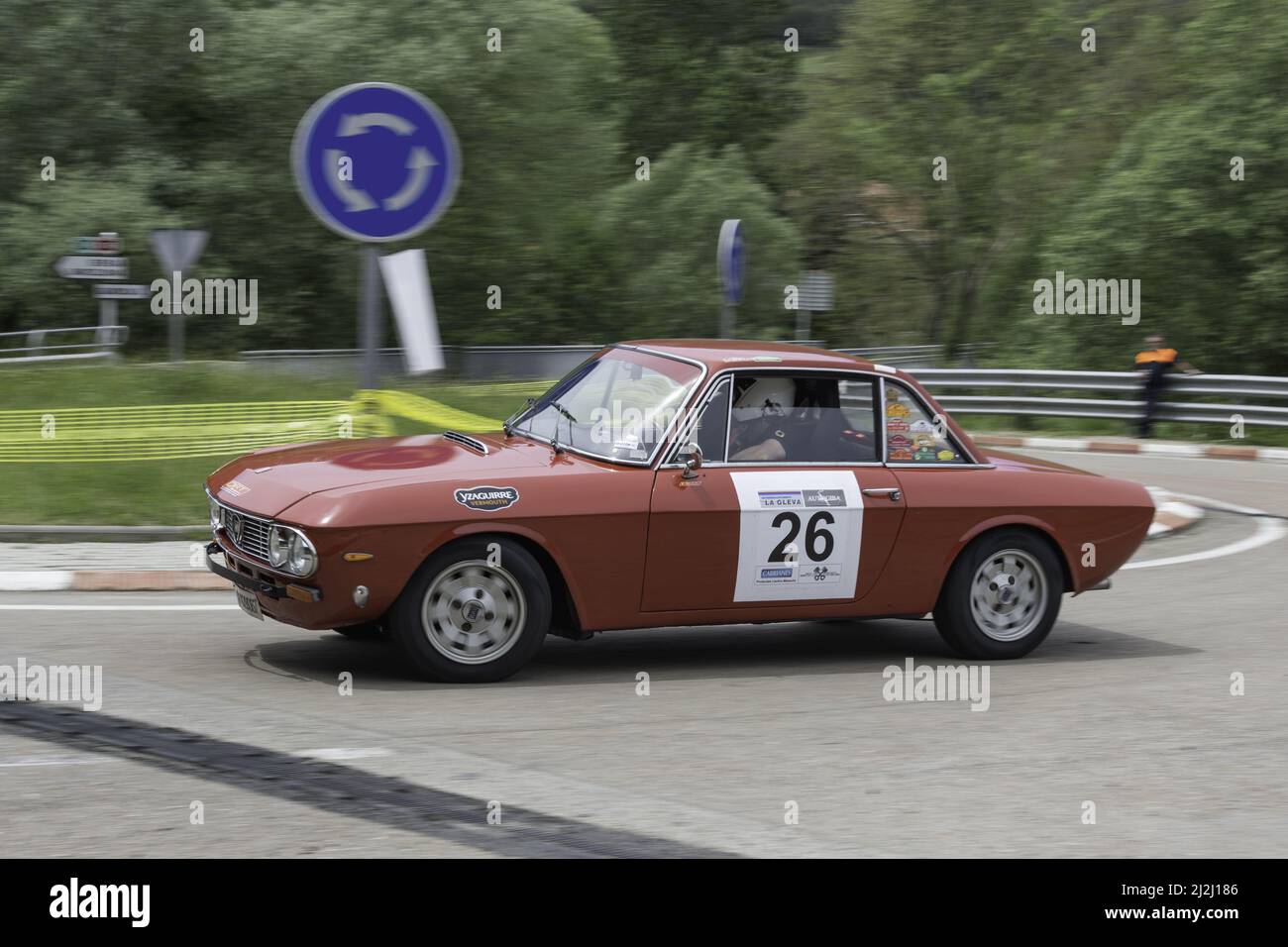 A closeup of an old and classic red Lancia Fulvia rally car in the ...