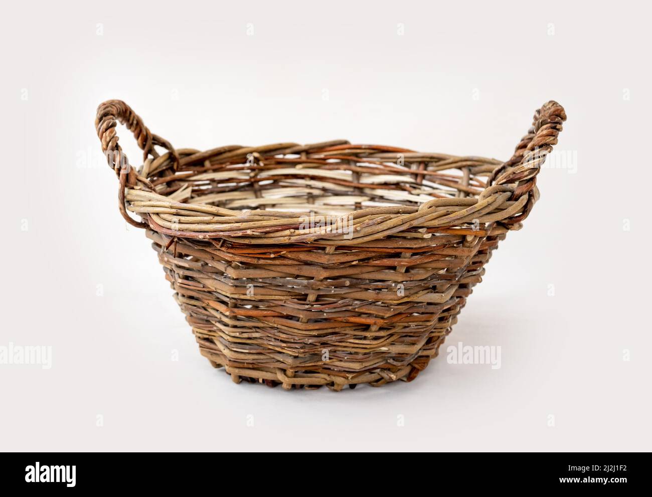 Rural wicker basket isolated on white background. Handmade craft ...