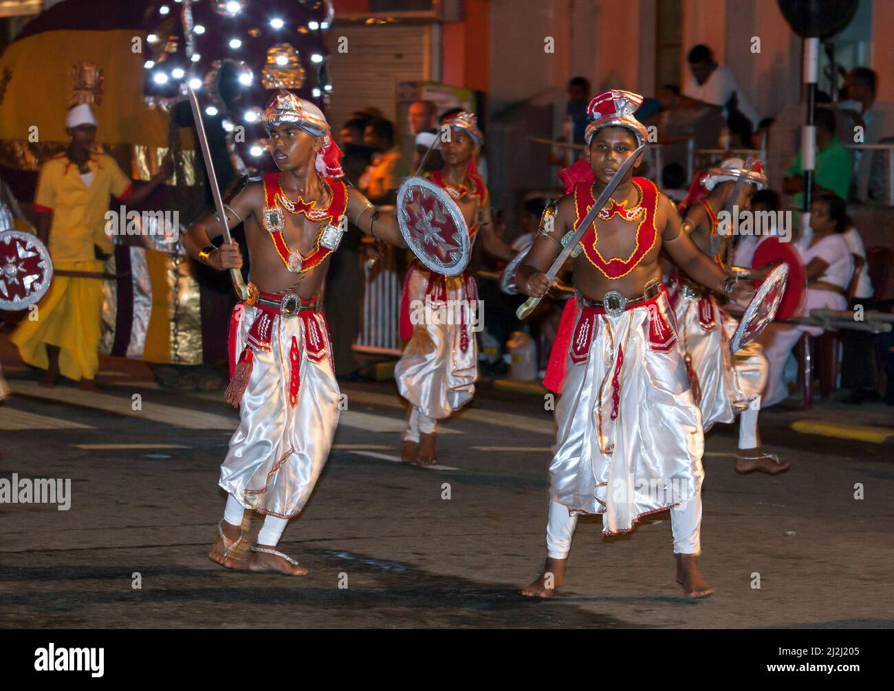Sword Dancers perform along a street at Kandy in Sri Lanka during the ...