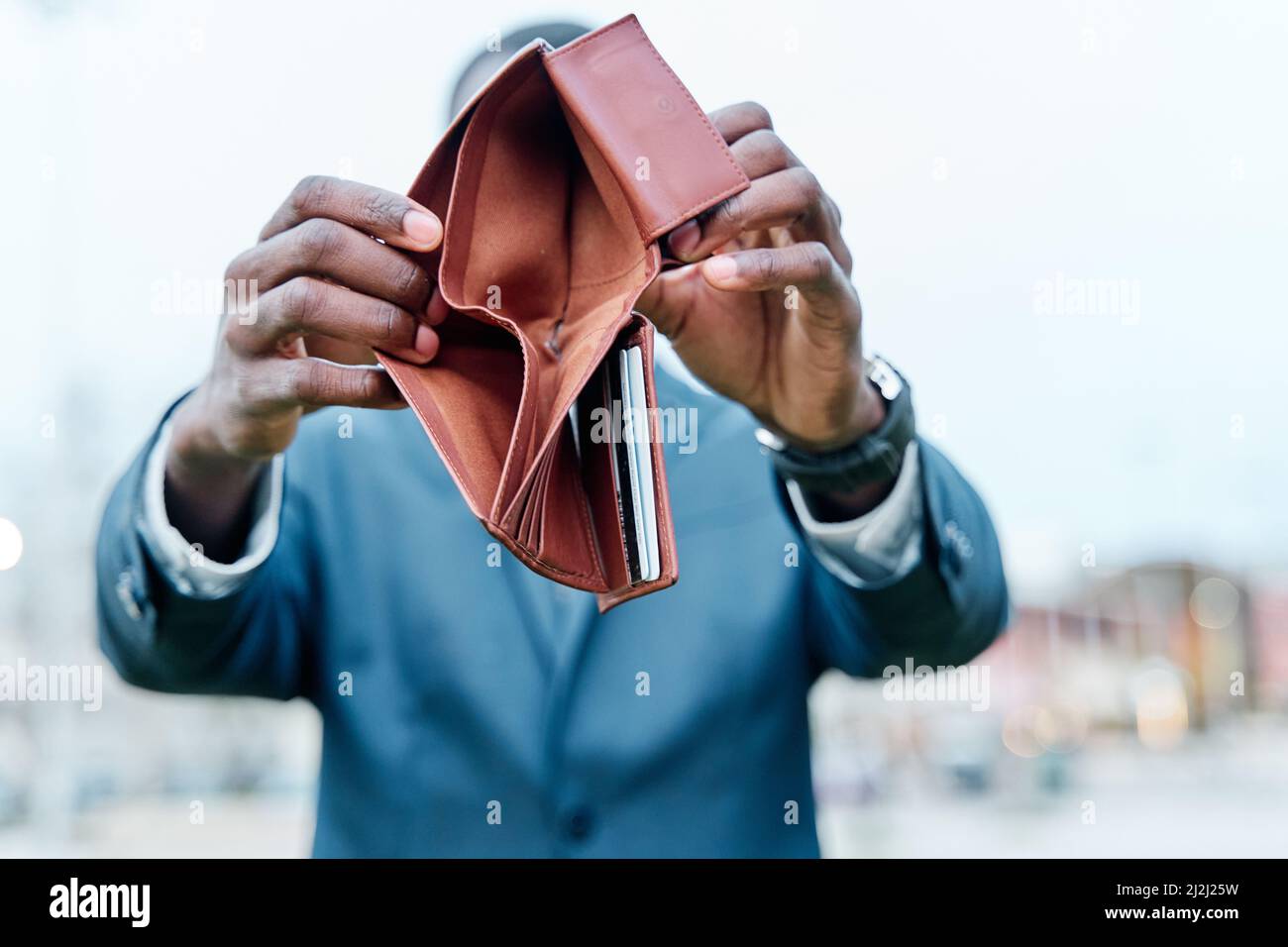 selective focus of an empty purse man and African-American man with ...