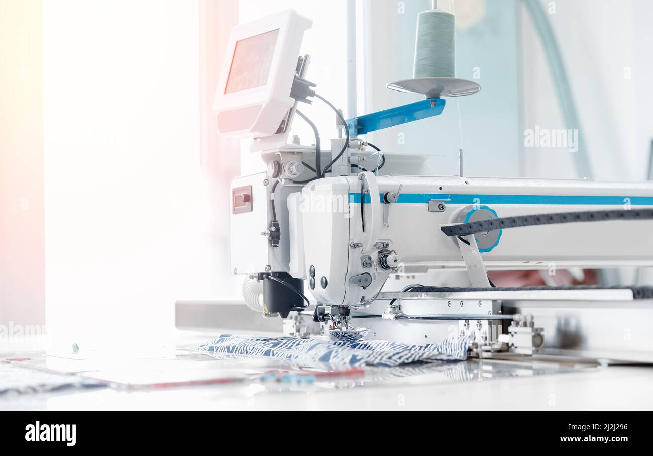 Closeup sewing machine with thread, background white color sun light ...