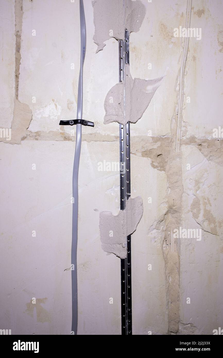 Electrical Cable laying on wall. Wiring replacement. Connecting light ...