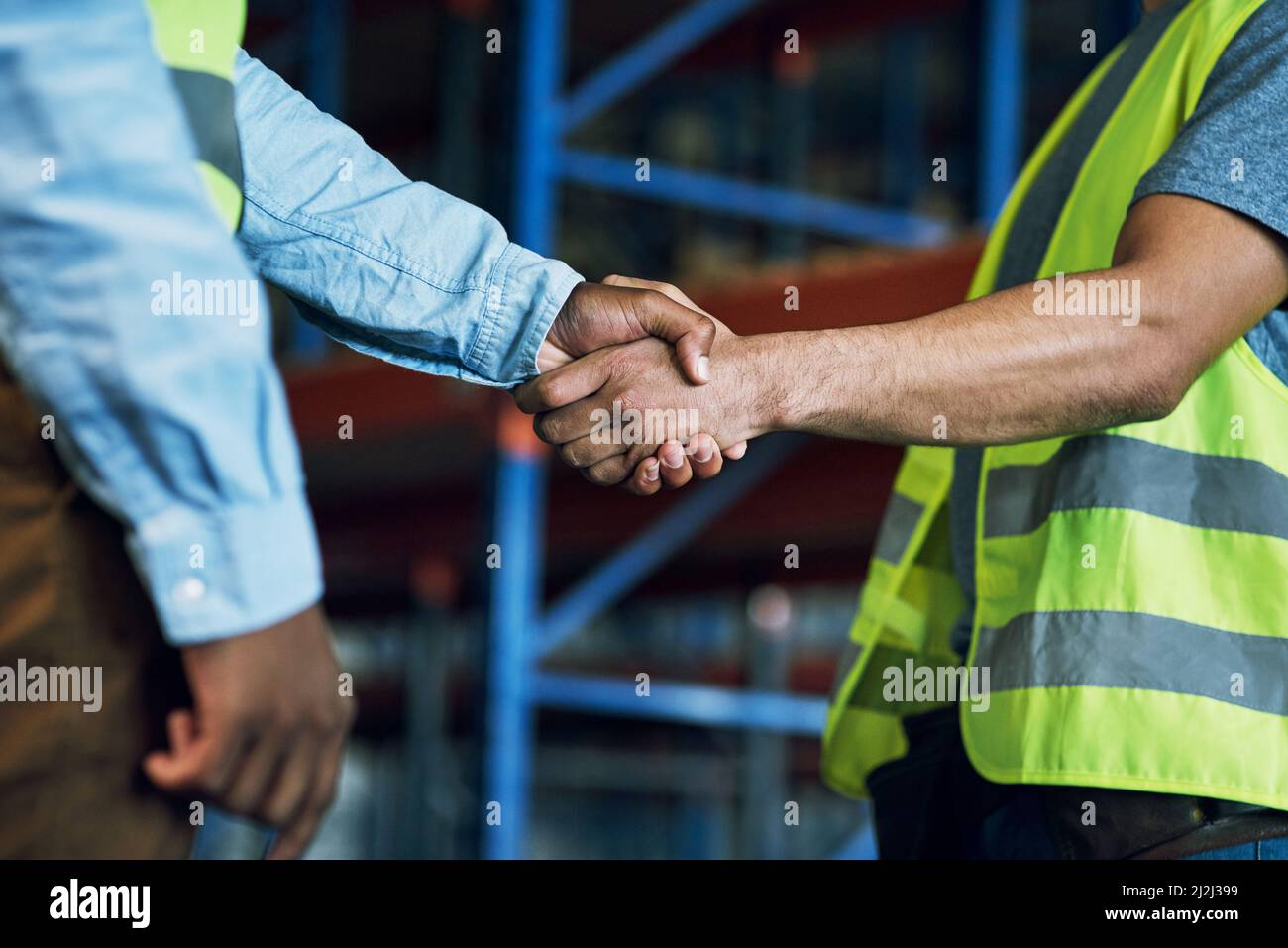 Proud to have a reliable partner like you. Shot of two builders shaking ...
