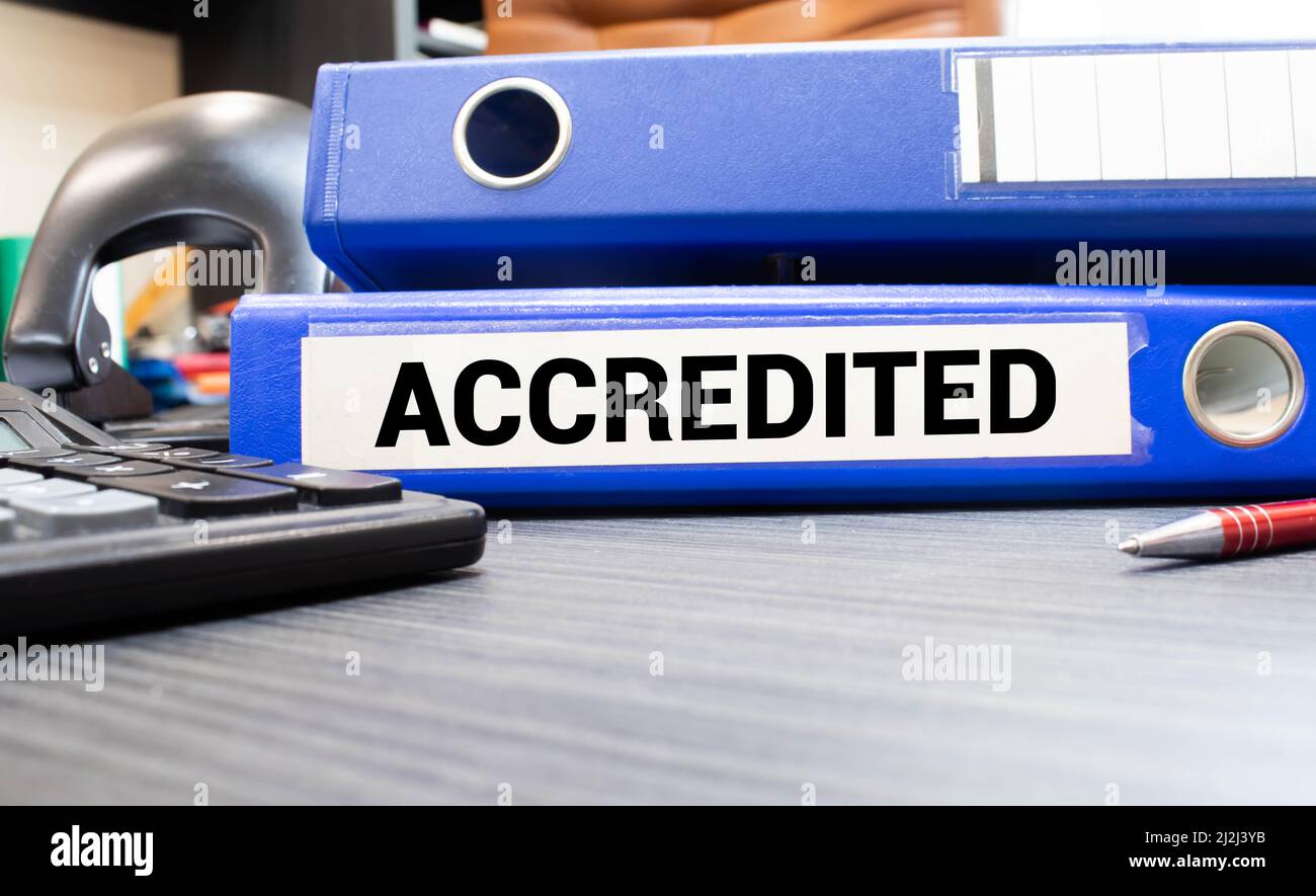 Accredited write on a paperwork isolated on office desk Stock Photo - Alamy