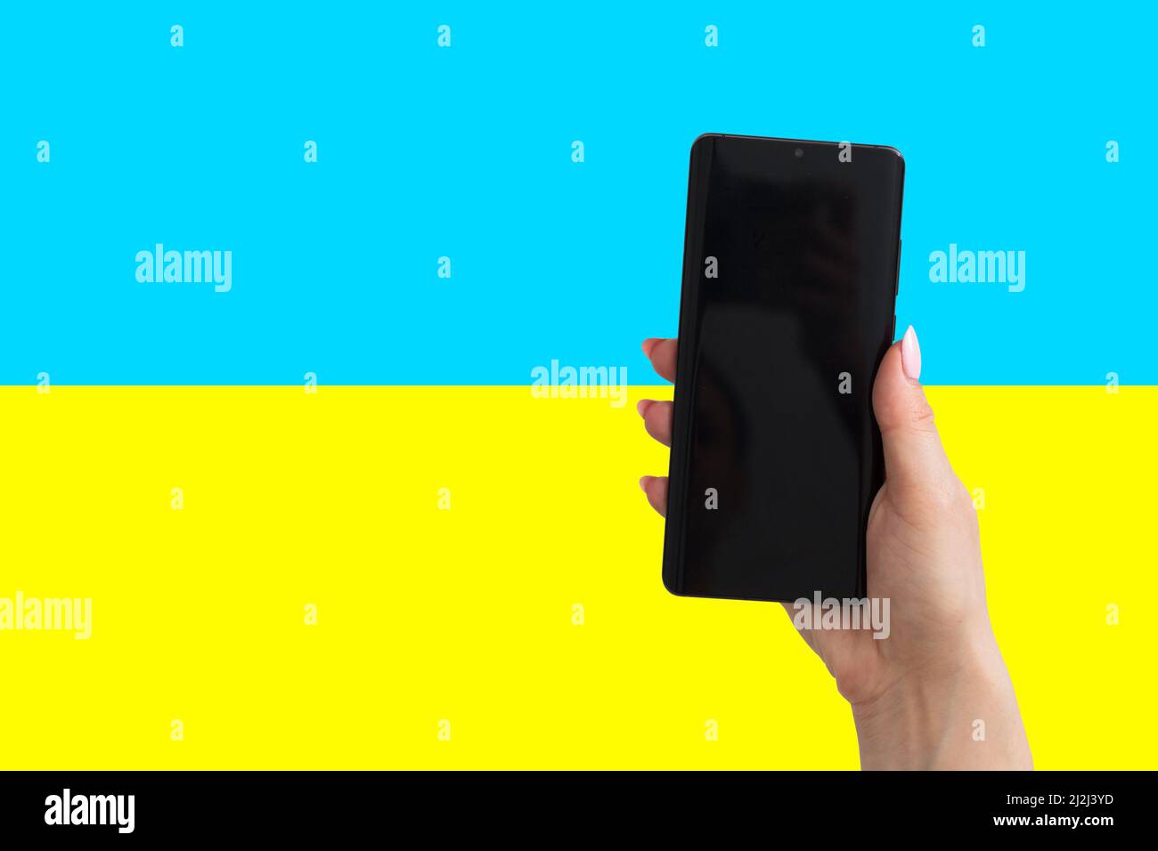 Illustration of a hand holding a smartphone with the flag of Ukraine ...