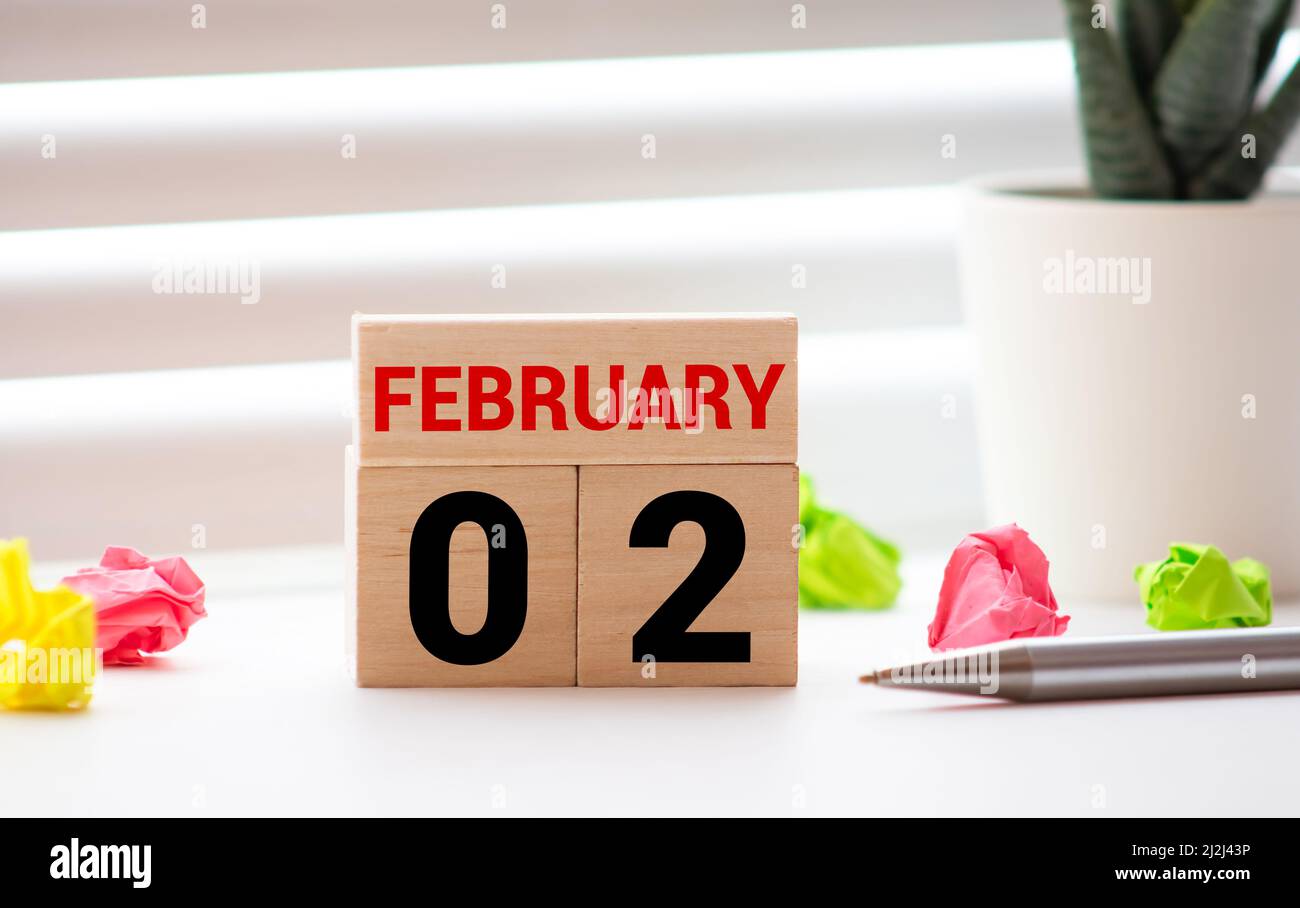 Wooden cubes calendar with the date of February 02. Concept calendar ...