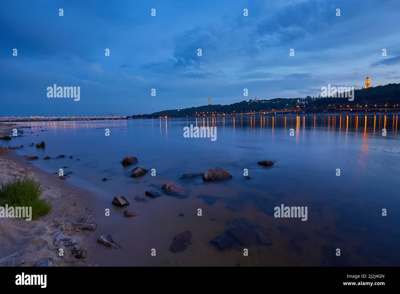 Evening view of Kyiv, night city lights, bridge over the river ...