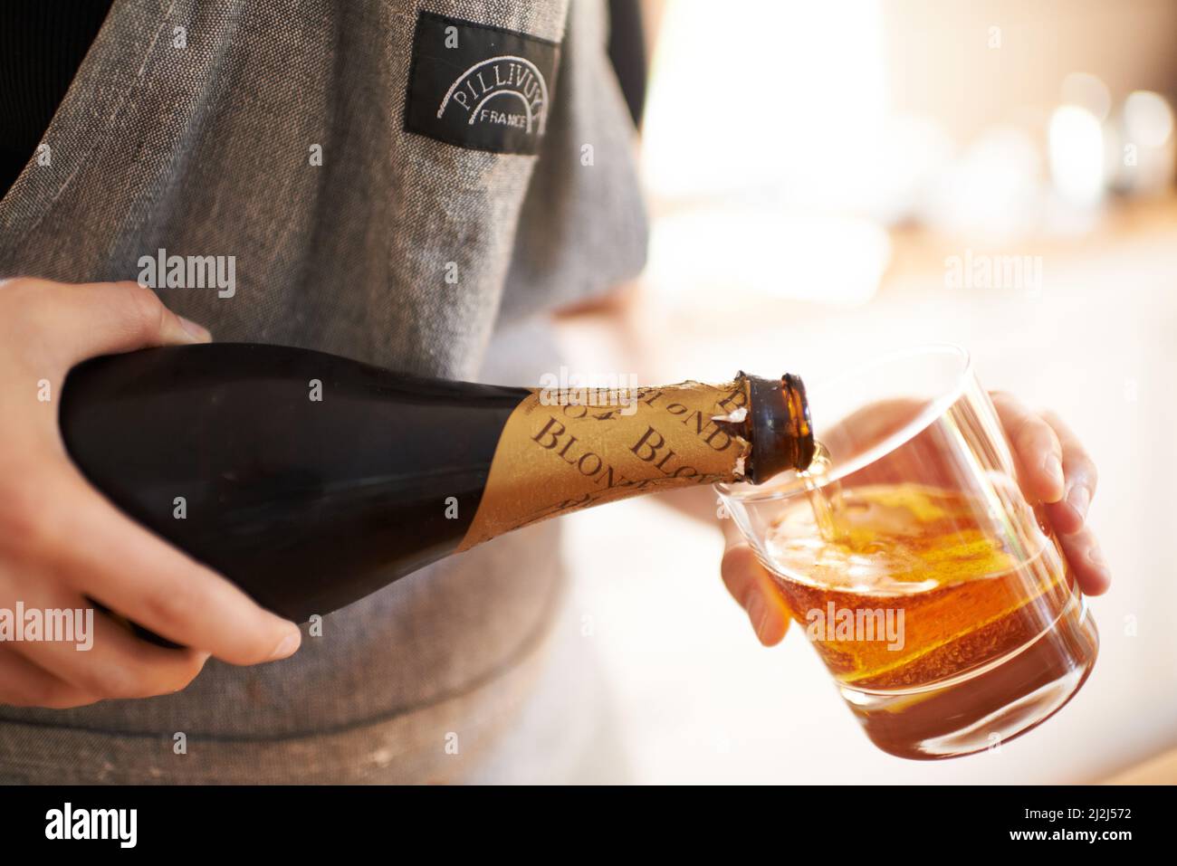 Pouring the perfect drink. Cropped view of a womans hands pouring a ...