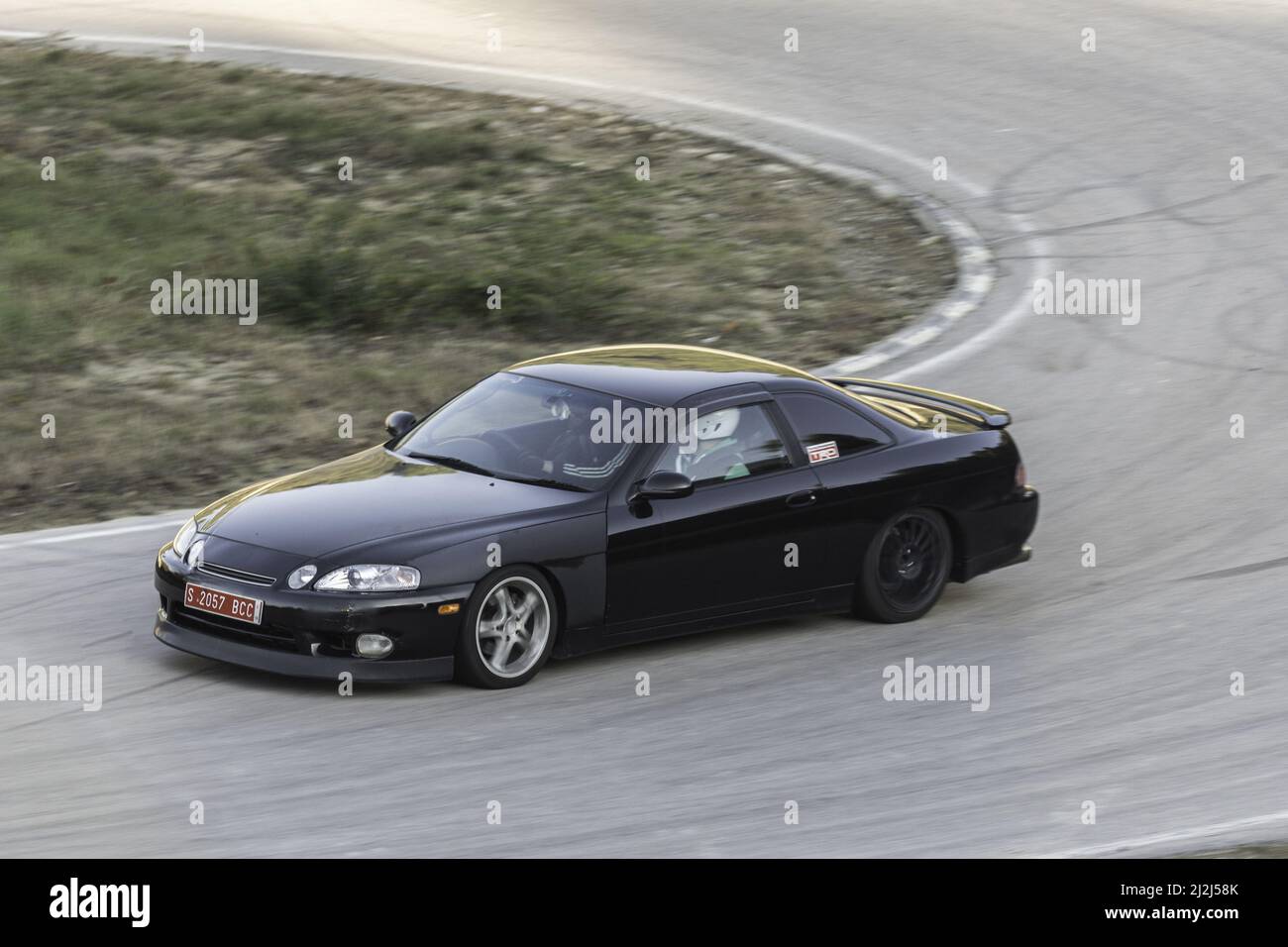 A Japanese custom car on the track, model color black. Lexus SC300 ...