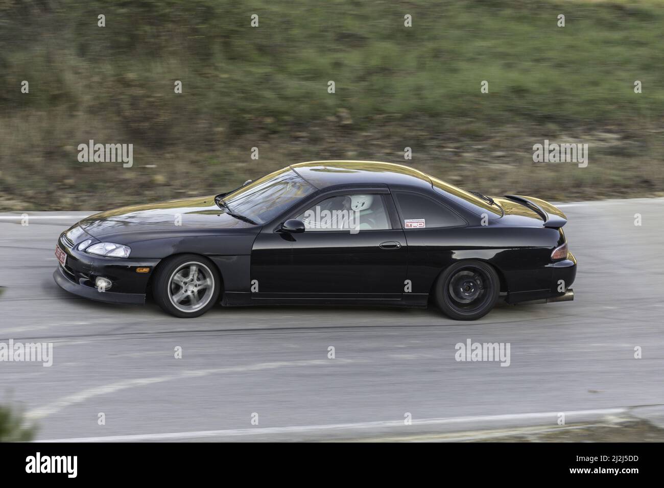 A Japanese custom car on the track, model color black. Lexus SC300 ...