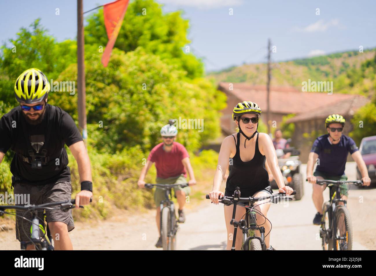 Group of friends are having a great time together while riding bikes on ...