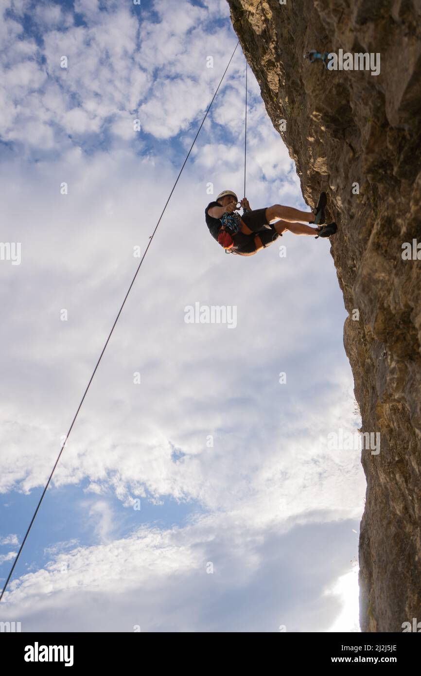 Fit senior guy is climbing the mountain hill while thinking a lot about ...
