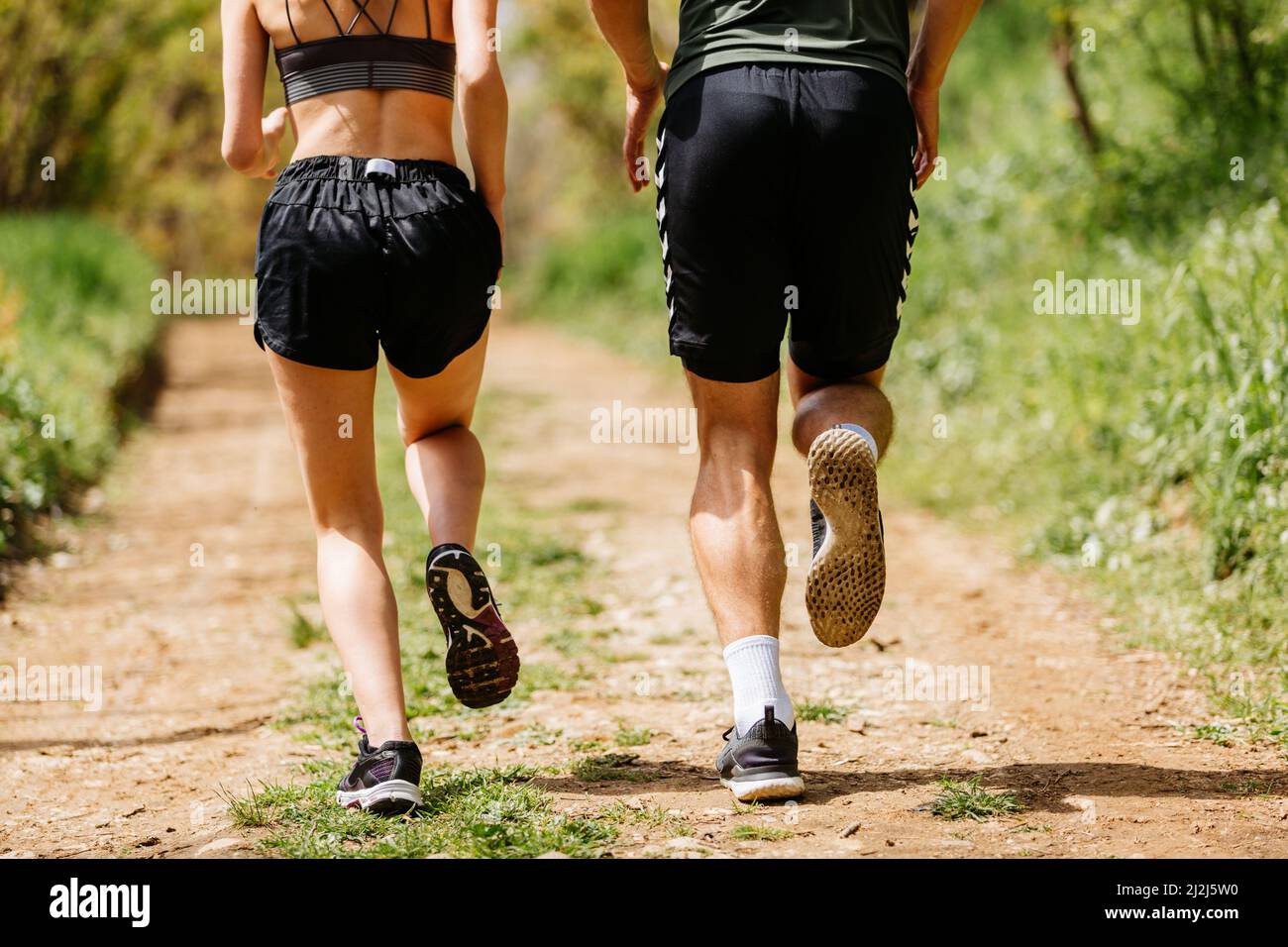 Sport people running in park together. Young couple jogging at outdoor ...