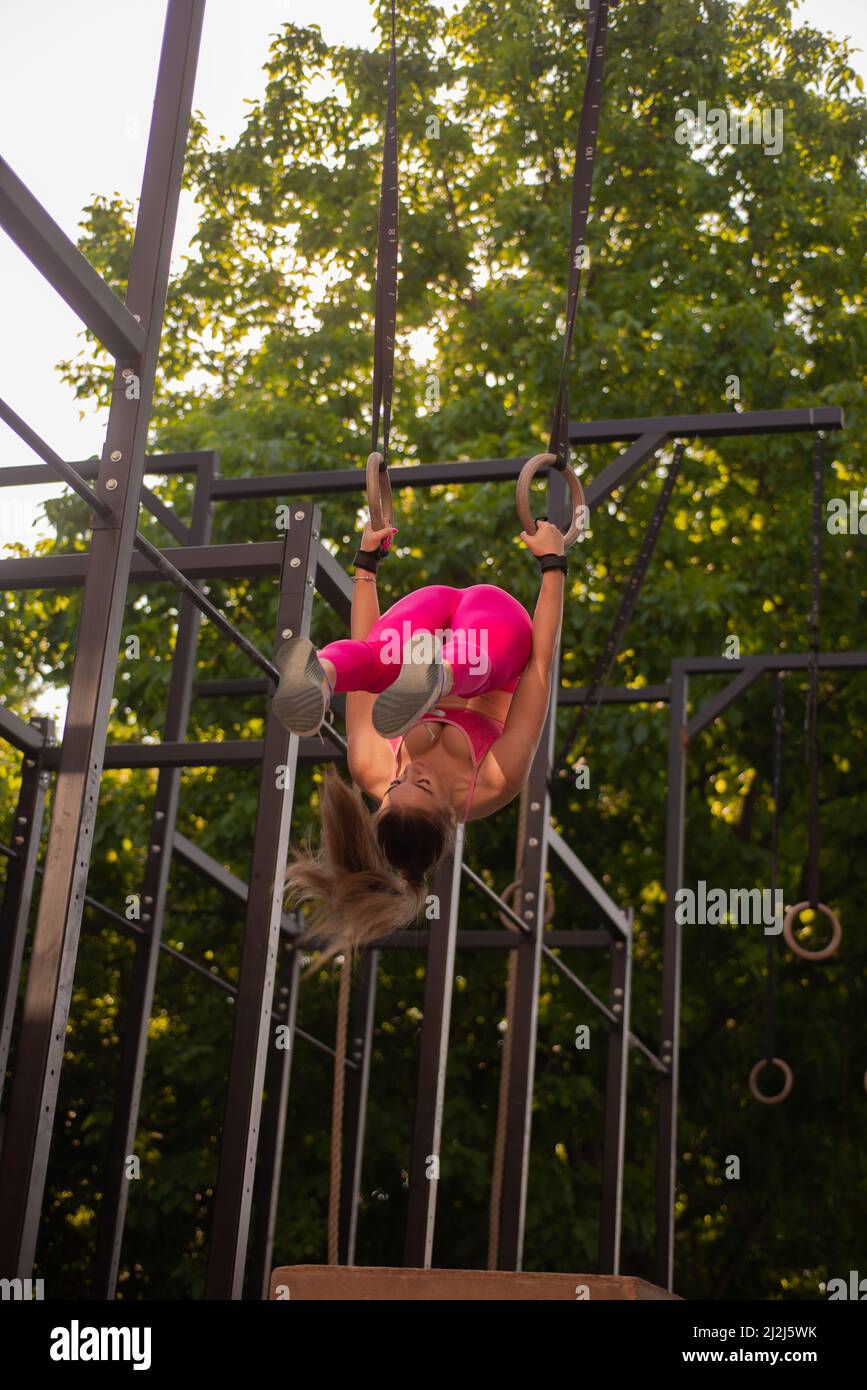 Attractive and beautiful girl is flipped over and being upside down ...