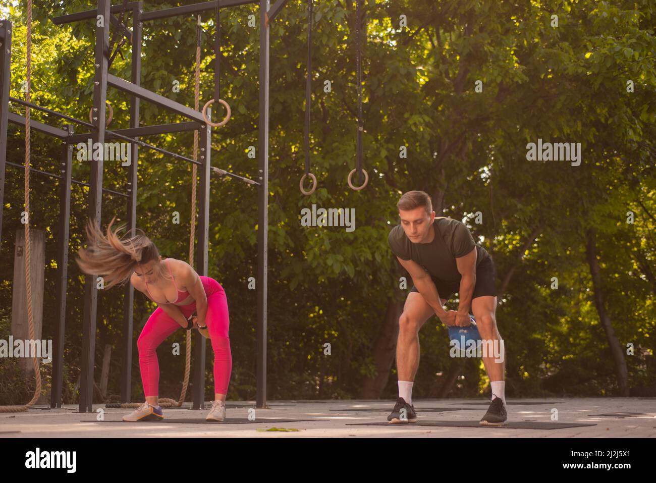 Beautiful and sweet couple is doing a lifting exercise together Stock ...