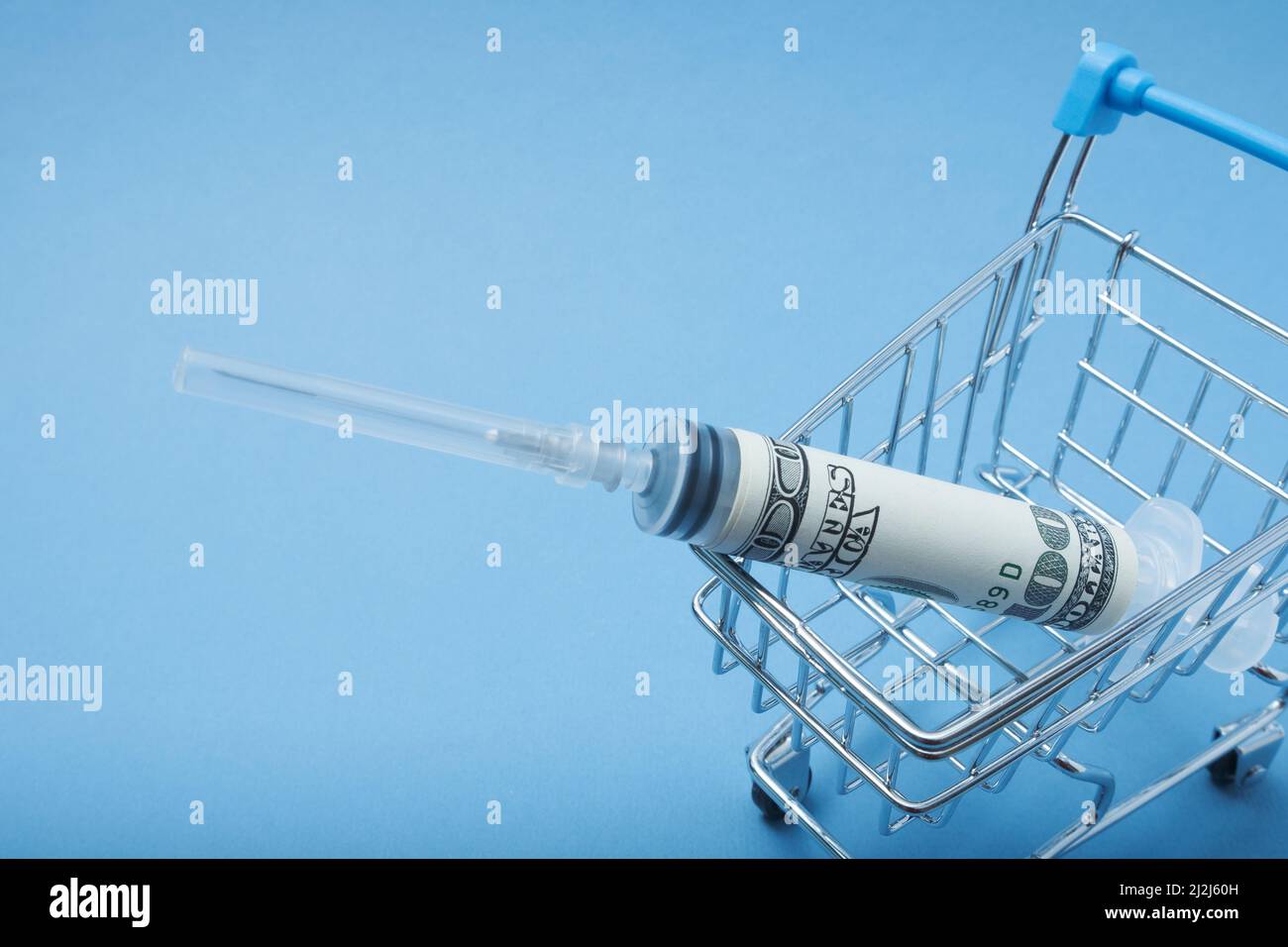 The syringe wrapped in a dollar is in the basket. Offering a financial ...