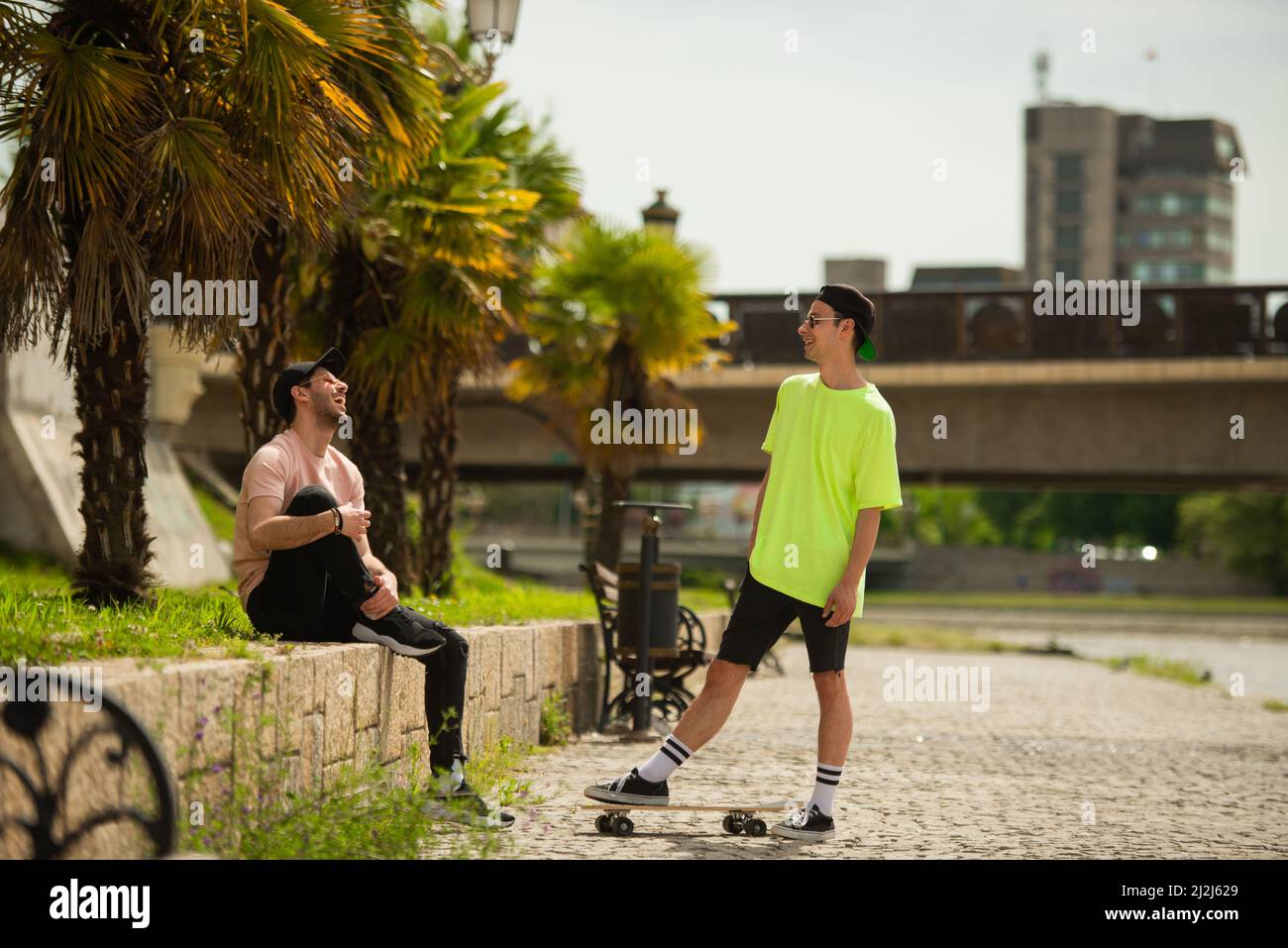 Two male friends are laughing while having a conversation Stock Photo ...