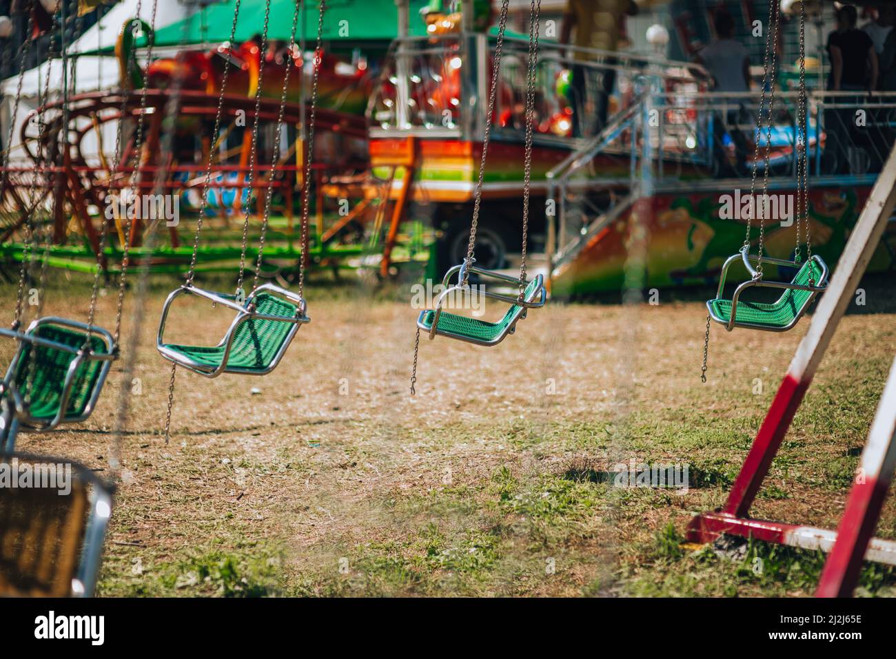 Hanging seats of a swinging carousel fair ride in theme park Stock ...