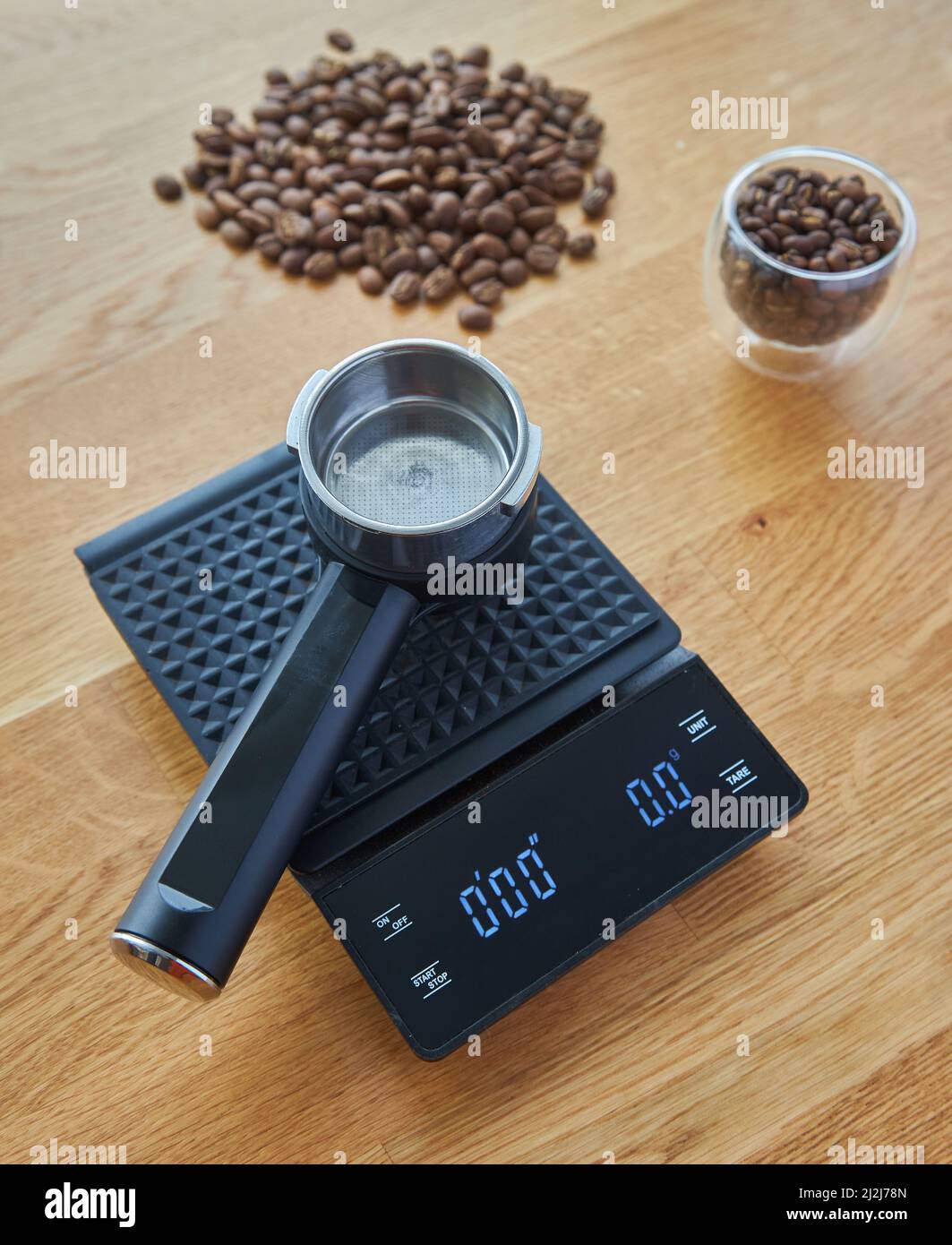 Coffee maker horn lies on coffee scales, on the background of wooden ...