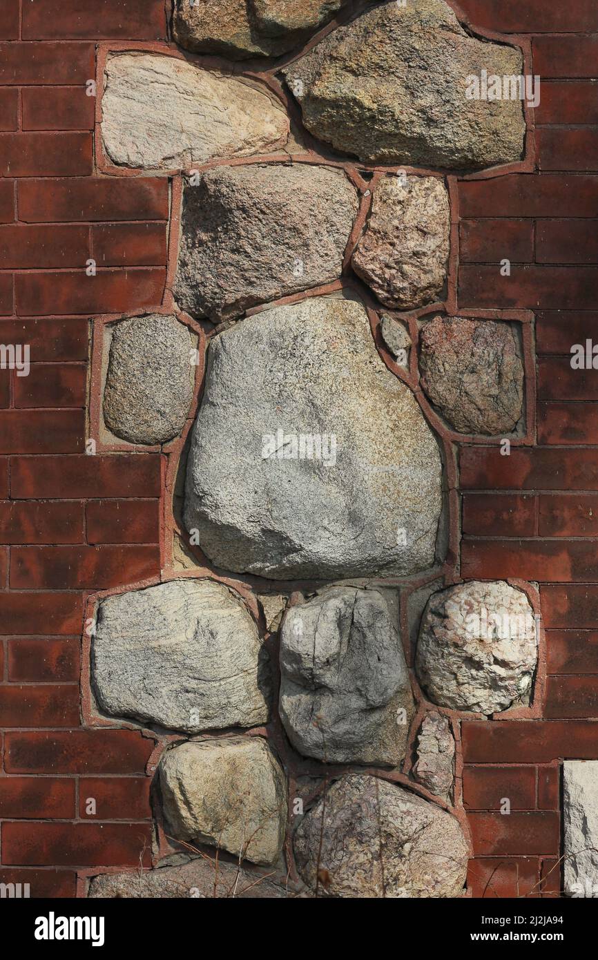 Rustic stone wall built with round boulders and granite stones Stock ...
