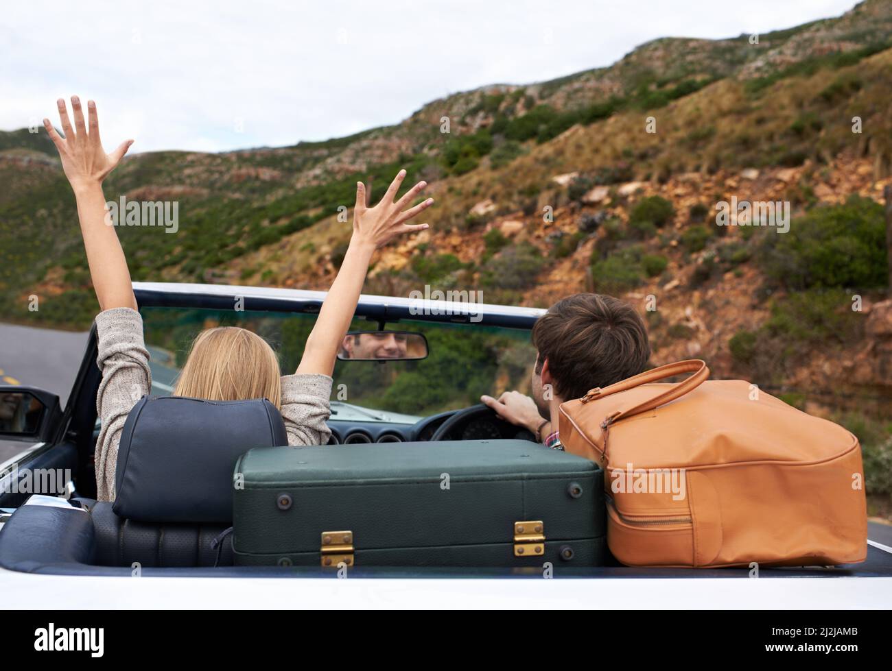 Hit the open road.... Rear view of a couple taking a road trip in a ...