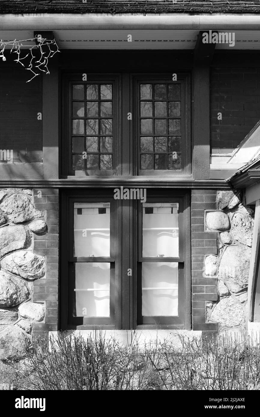 Vintage wooden windows on a charming rustic stone cottage in black and ...