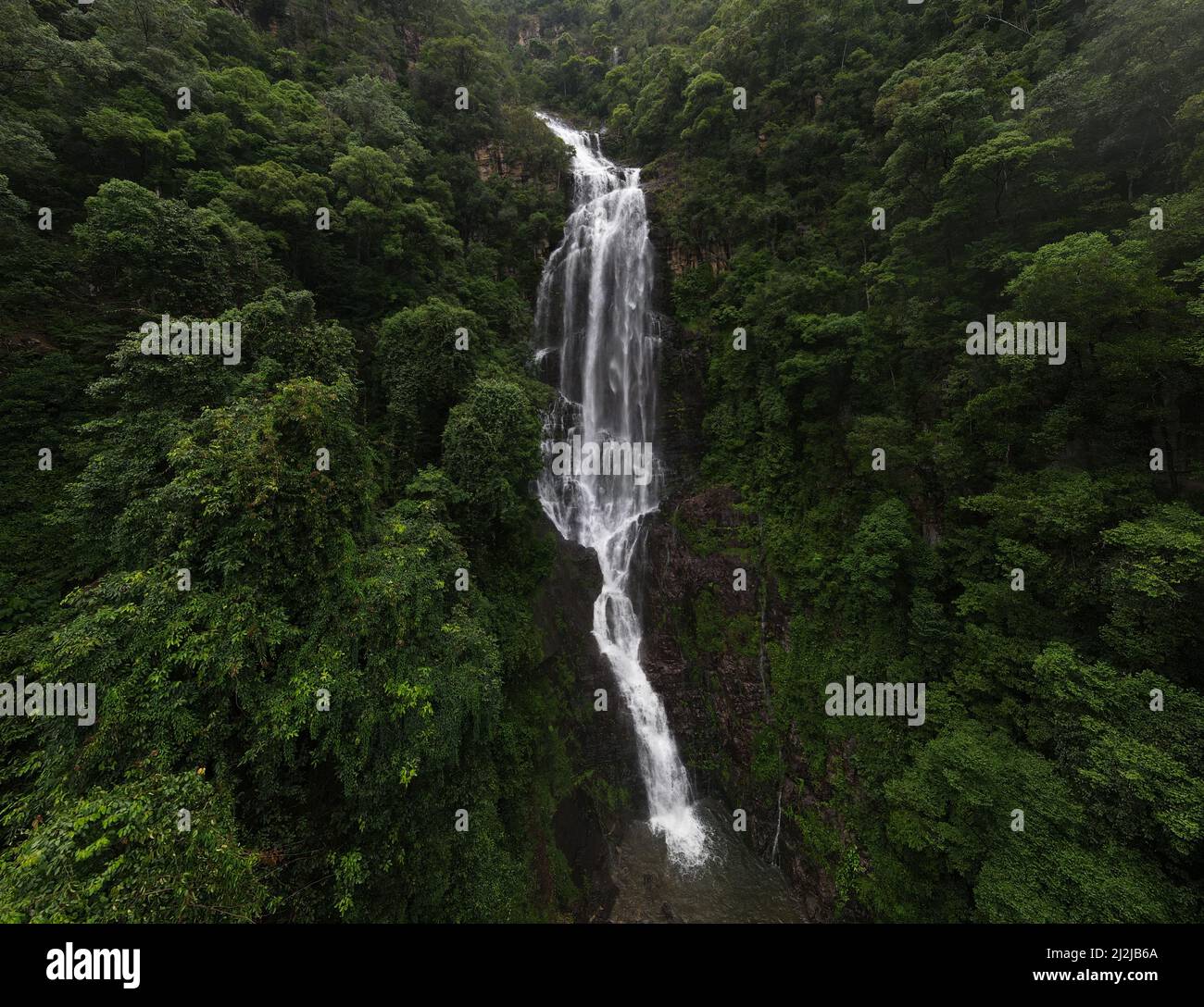 The aerial beautiful Temurun Waterfall shot in the middle of the forest ...