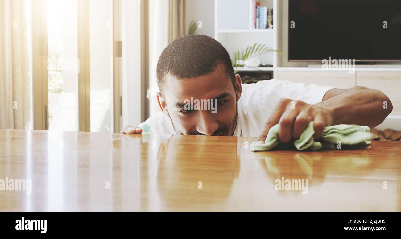 I have to pay attention to detail. Shot of a focused young man cleaning ...