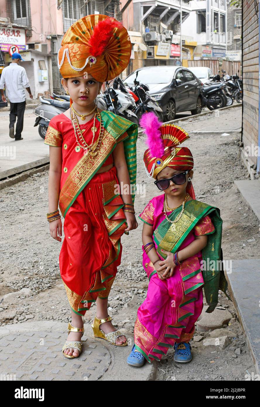 Children dressed in traditional clothes pose for a photo during the ...