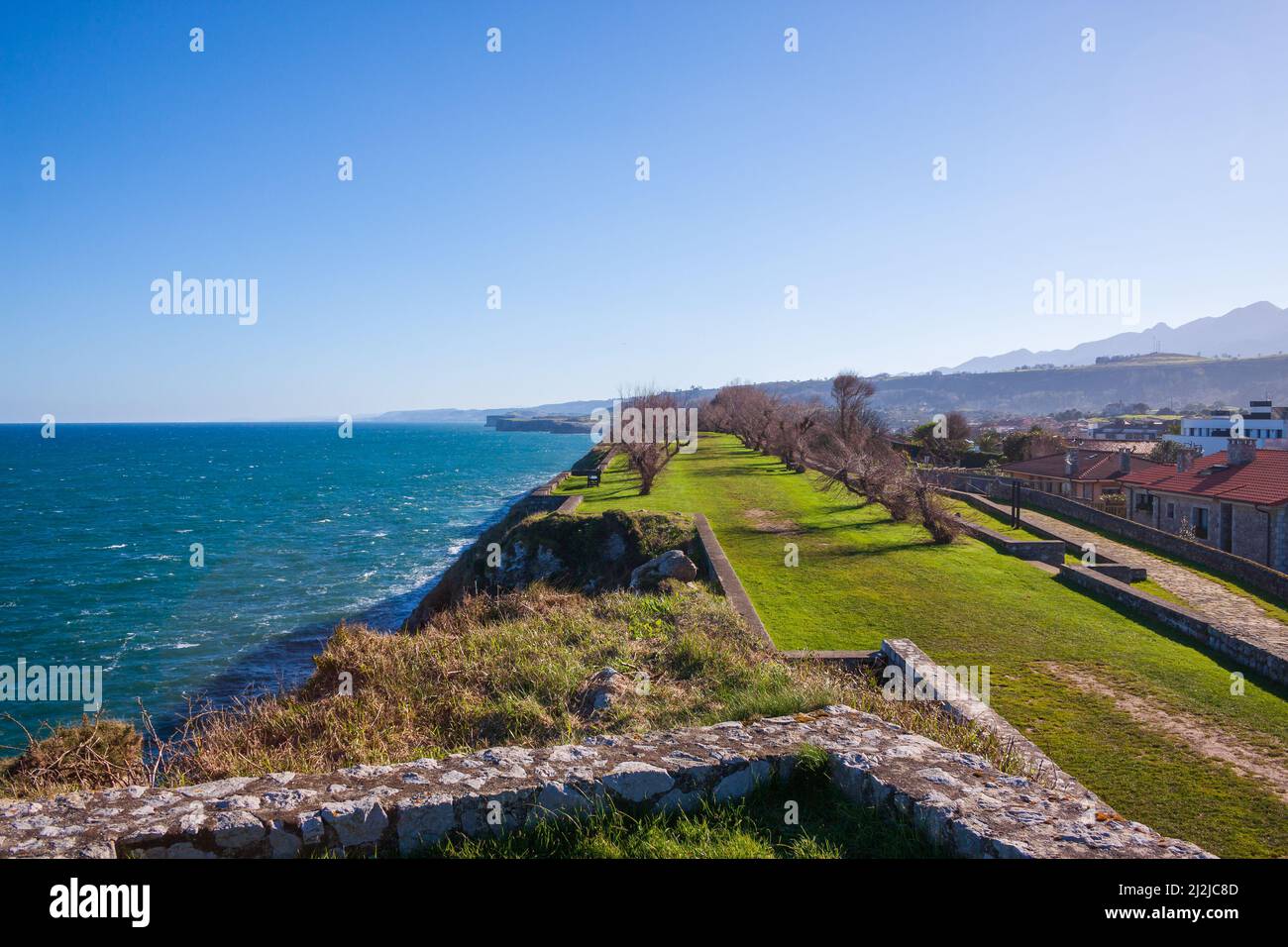A beautiful seaside view with leafless trees and typical buildings in ...